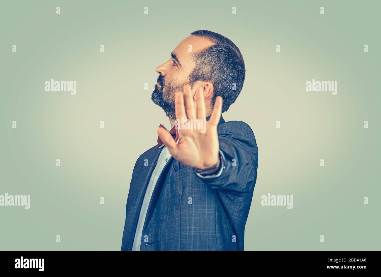 Annoyed mature man with bad attitude giving talk to hand gesture ...