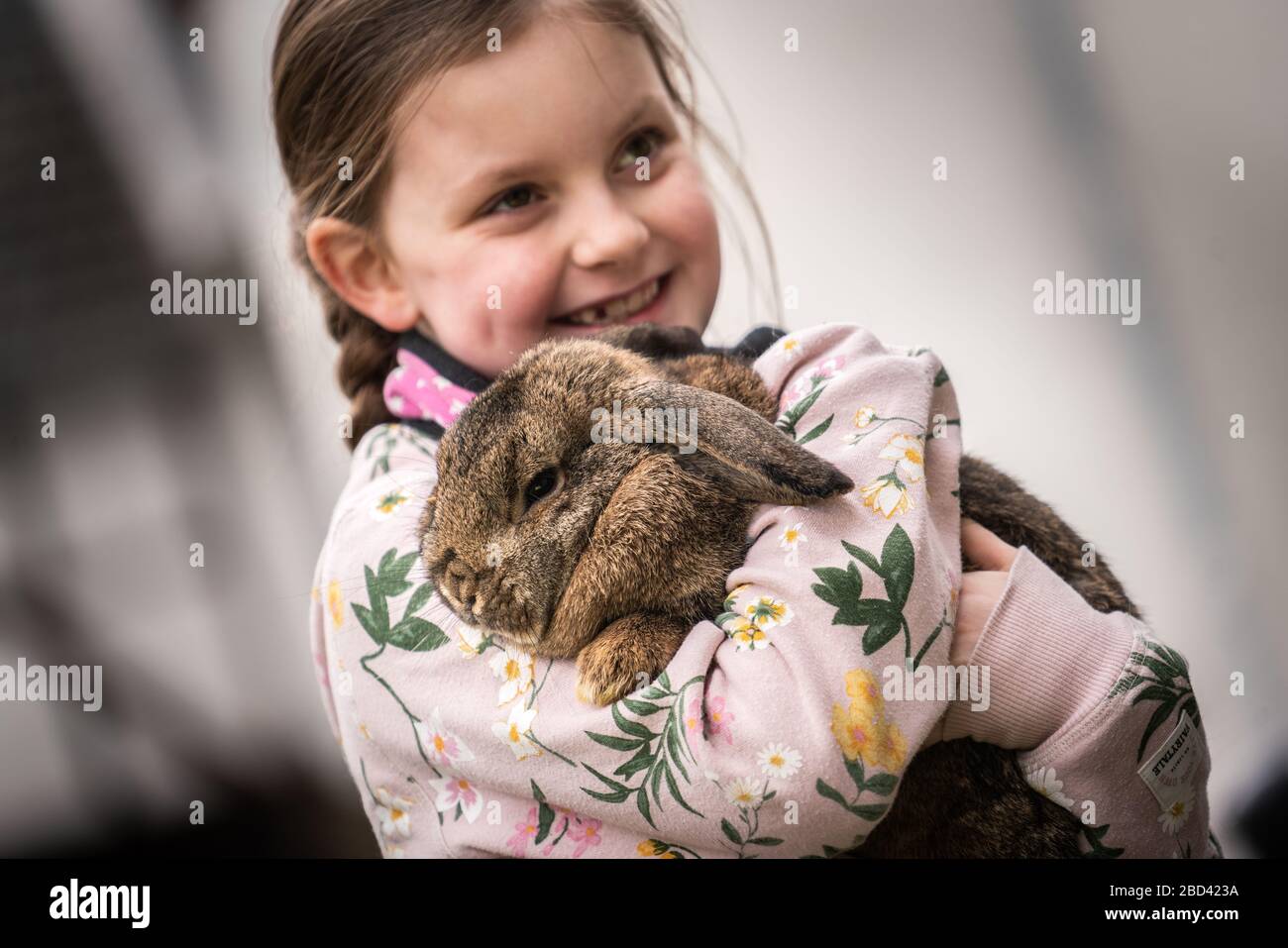 03 April 2020, Hessen, Hünfelden: Emma Jaide holds her dwarf rabbit ...