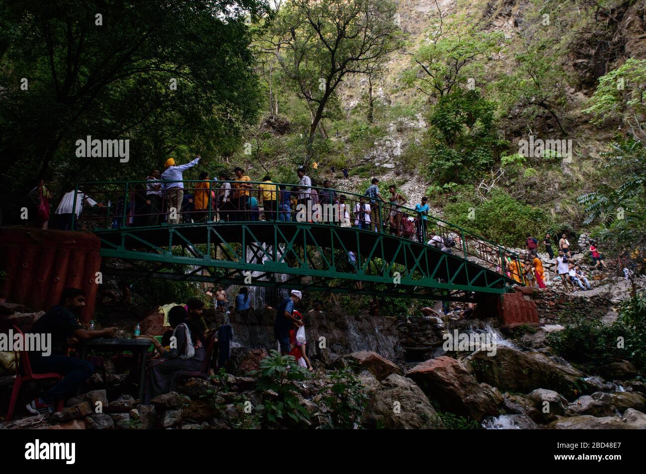 Group of people enjoying under the famous neer garh Waterfall ...