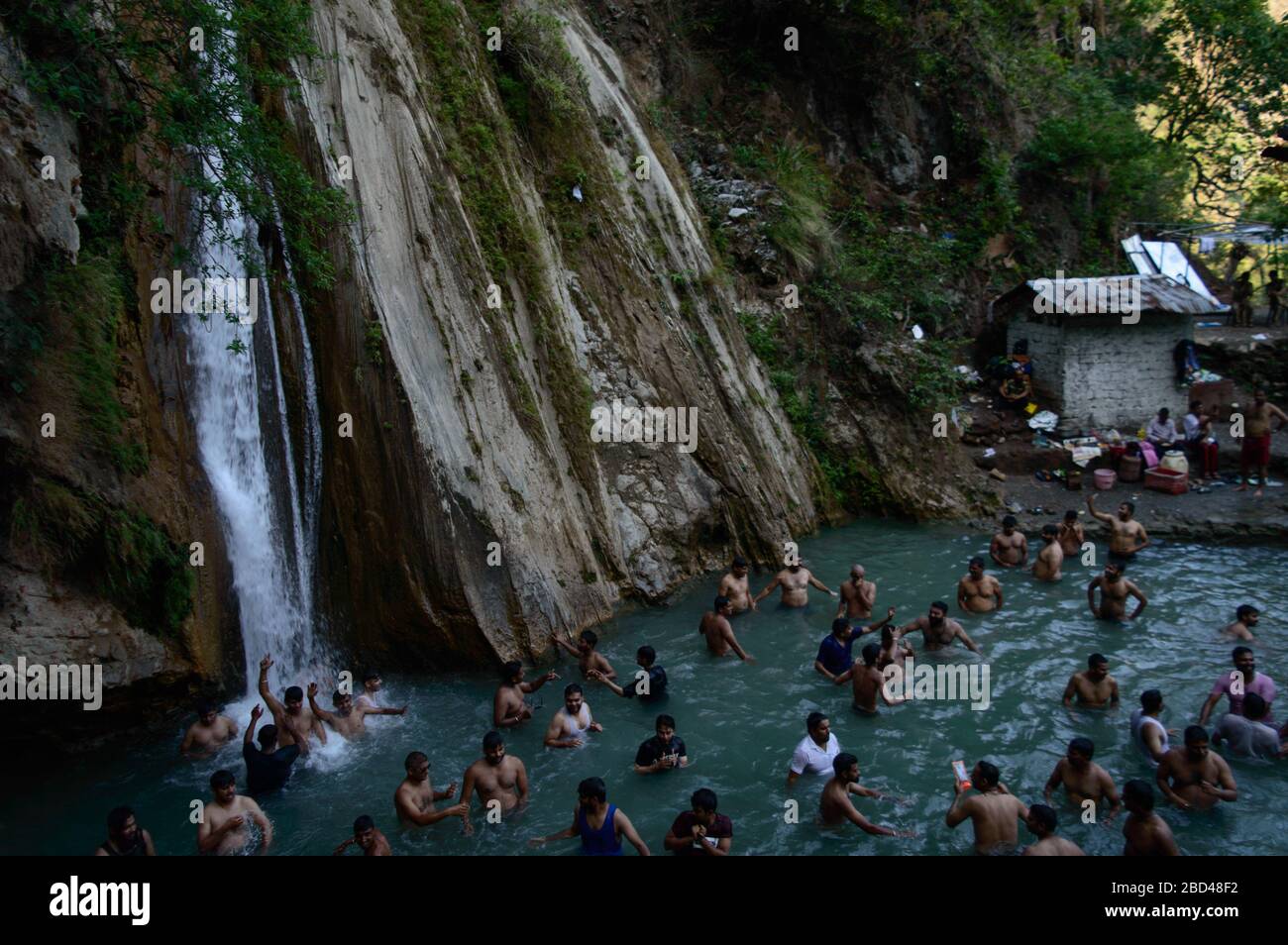Group of people enjoying under the famous neer garh Waterfall ...
