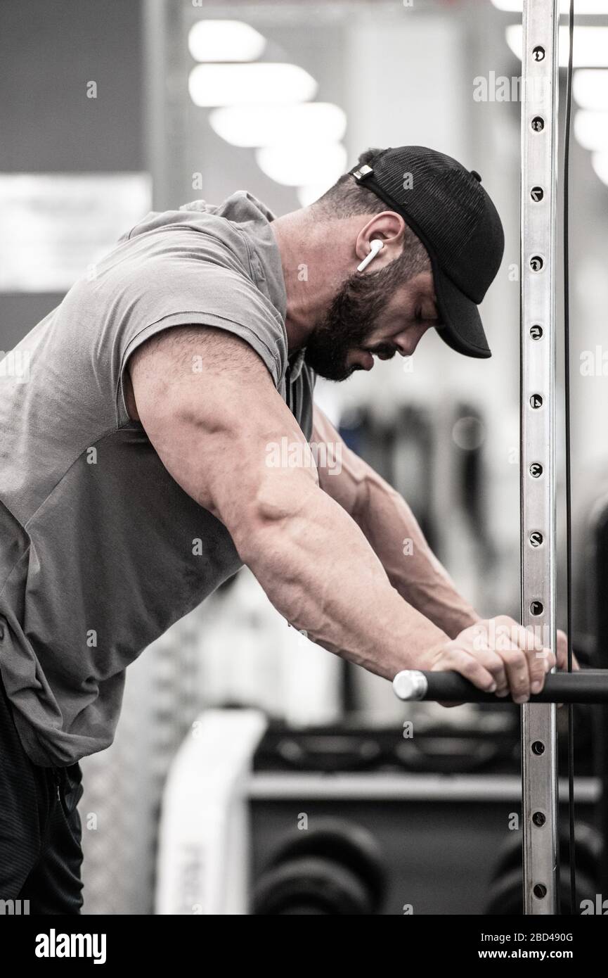 tired relaxing young strong man with beard resting during heavy weight ...