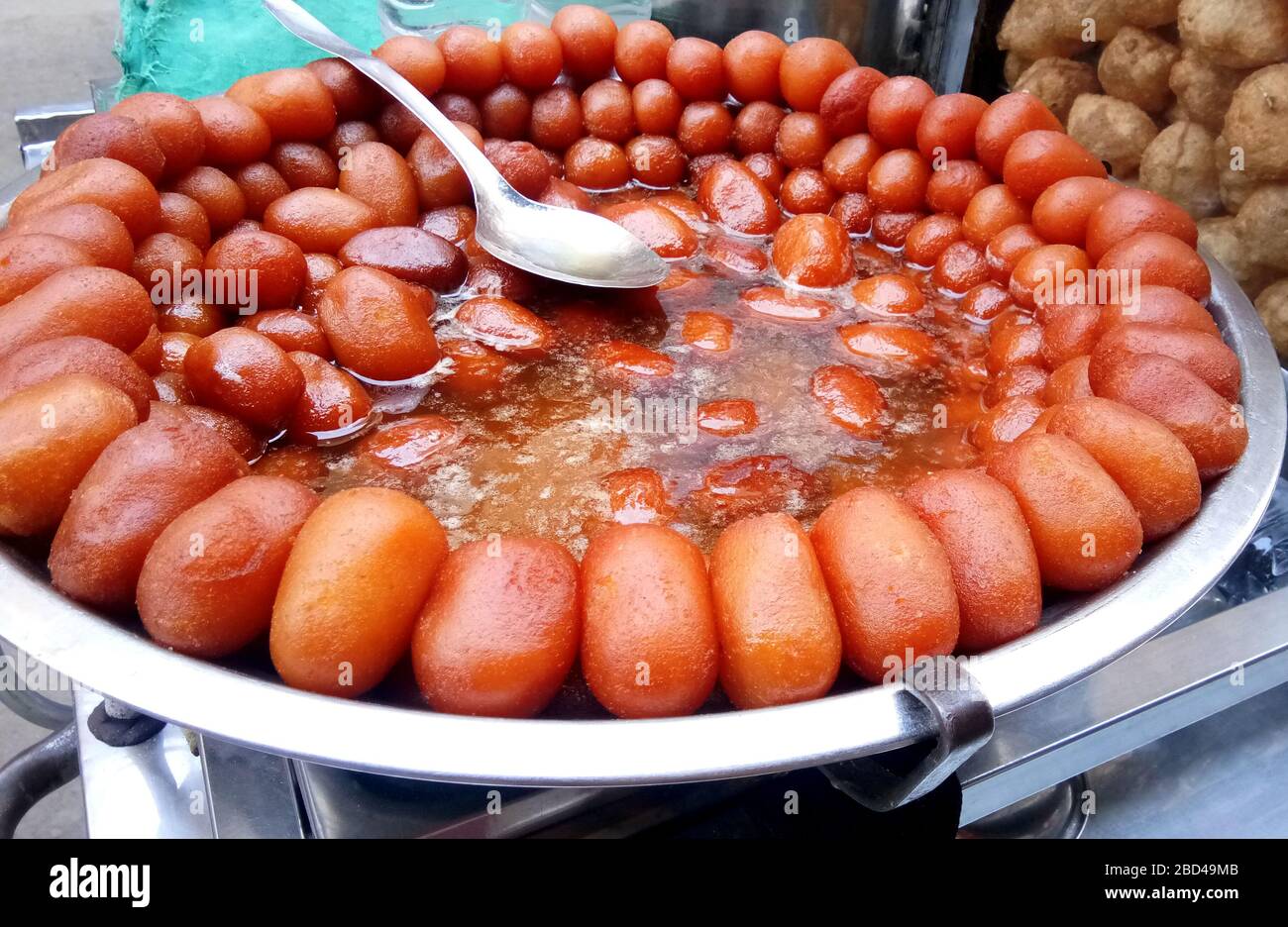 The indian sweet named "gulab jamun" is selling in local market Stock ...