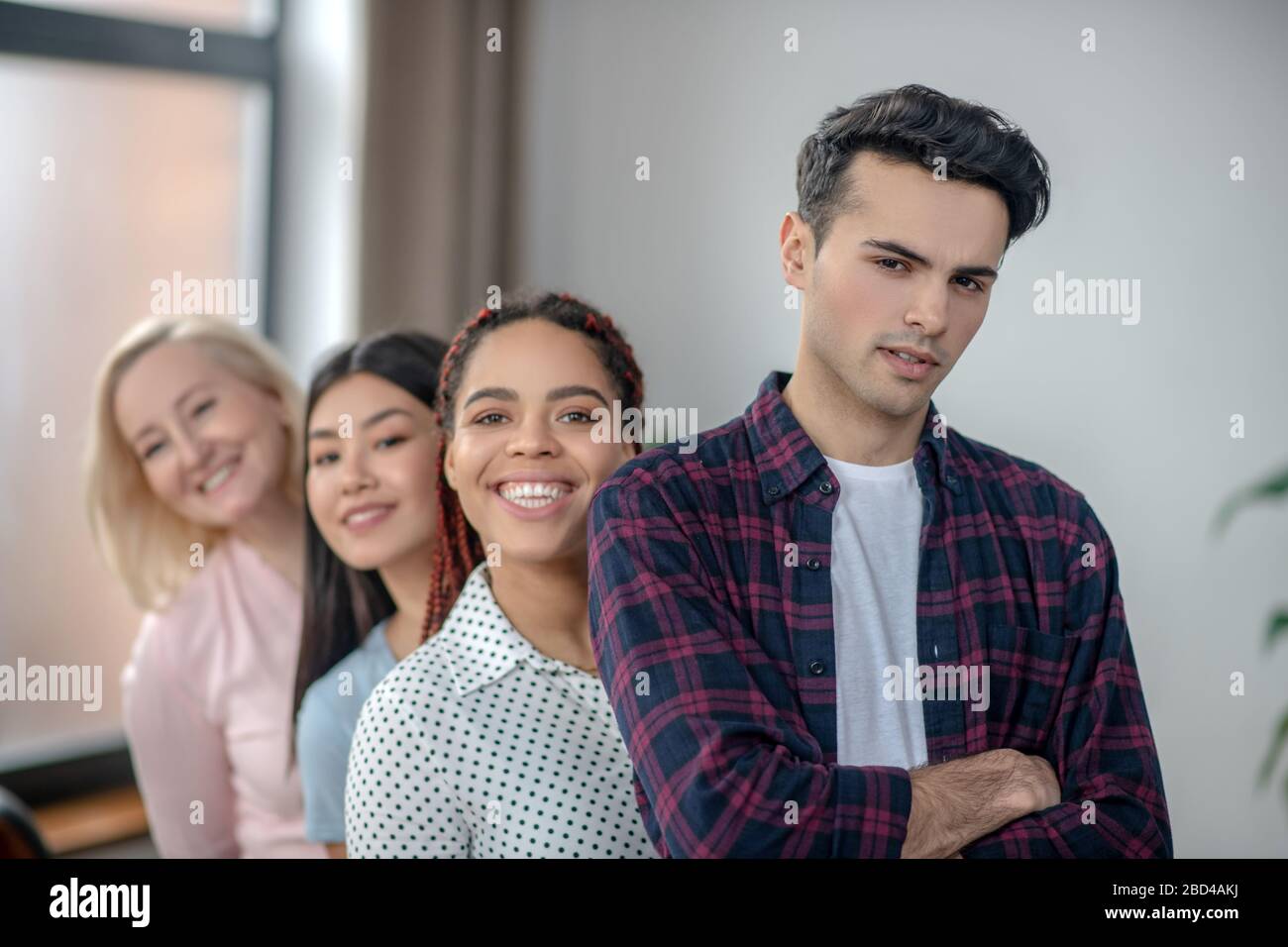 Group of people standing close and smiling Stock Photo - Alamy