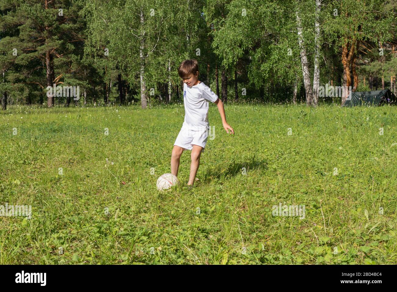 Boy playing soccer uniform hi-res stock photography and images - Alamy