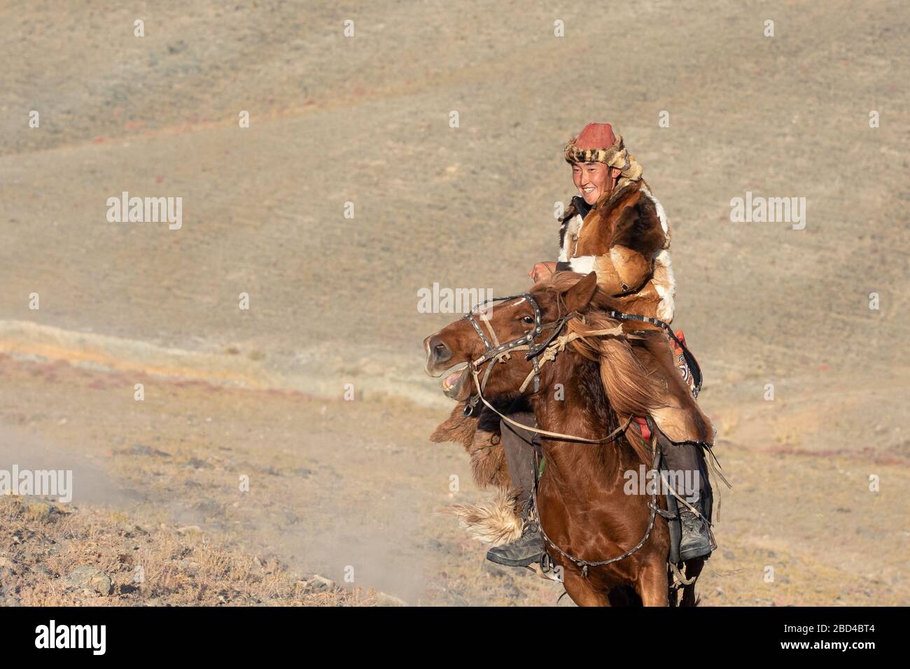 Kazakh eagle hunter after winning a traditional wrestling match. Two ...