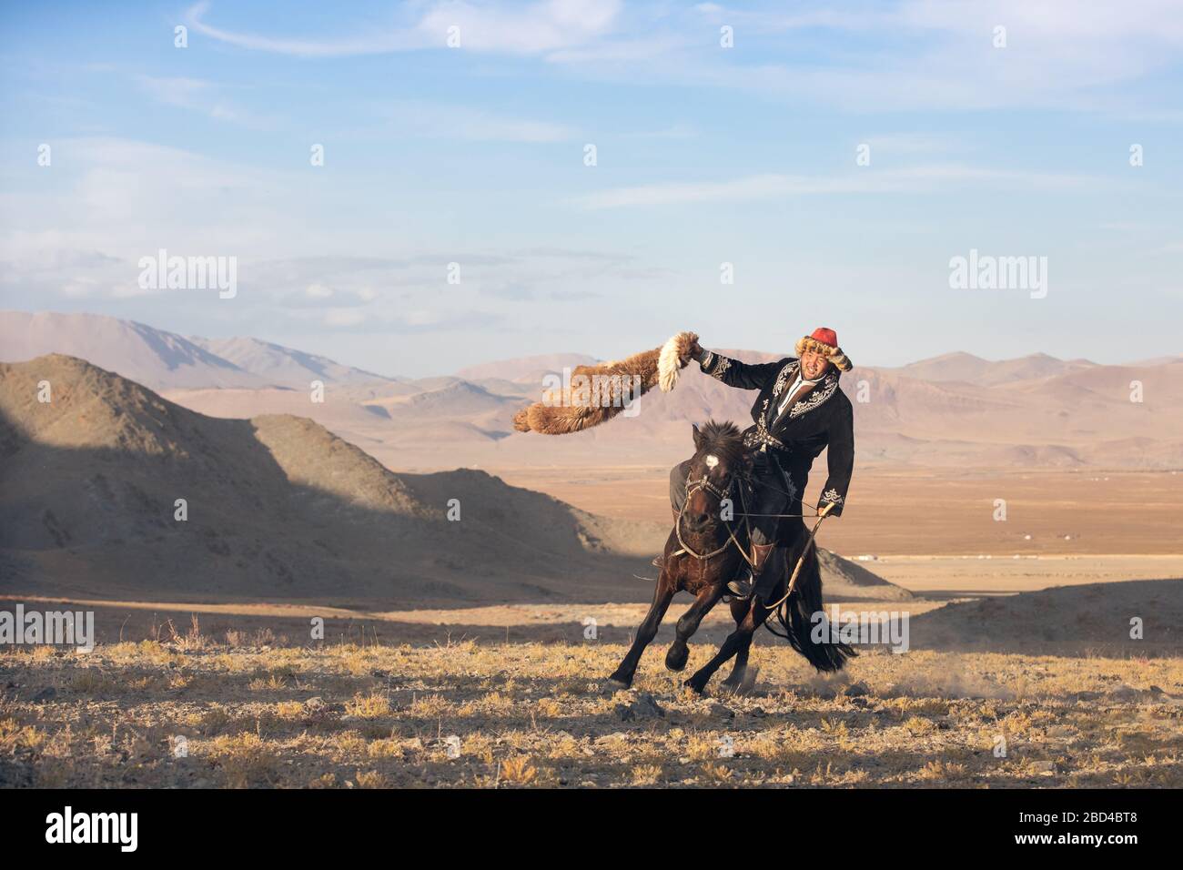 Kazakh eagle hunter after winning a traditional wrestling match. Two ...