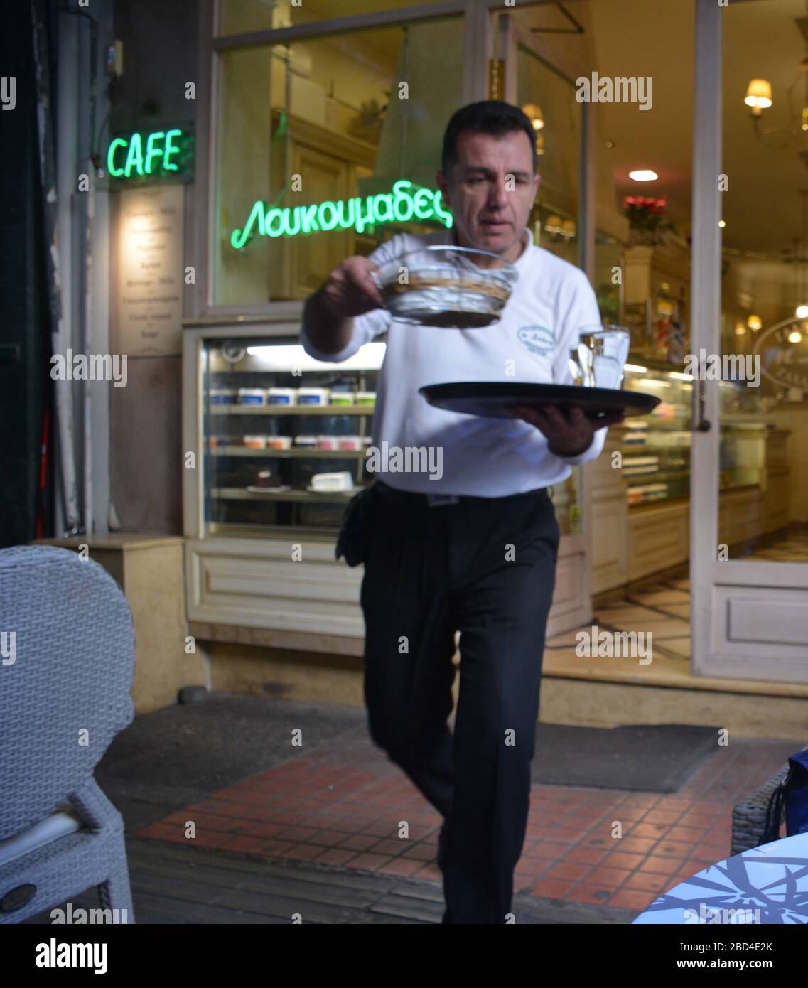 A waiter brings breakfast at Stani, a traditional cafe in central ...