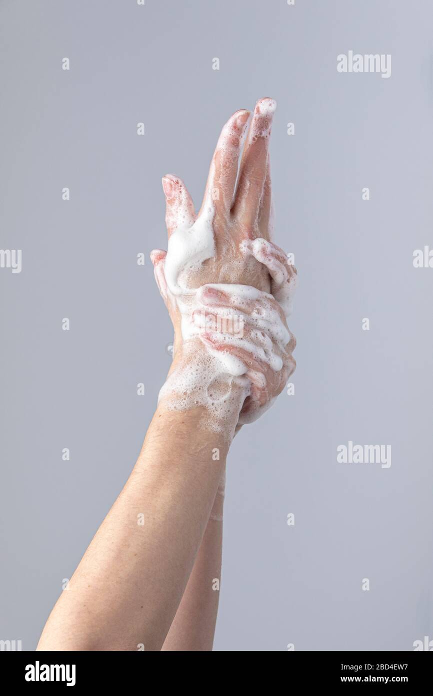 White people's hands washing each other with green foamy Marseille's ...