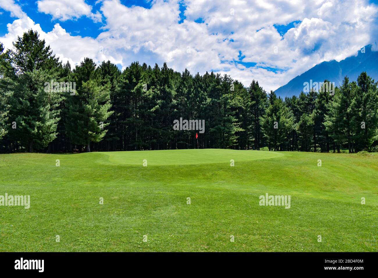 Beautiful lush green Golf Course surrounded by beautiful mountainous at ...