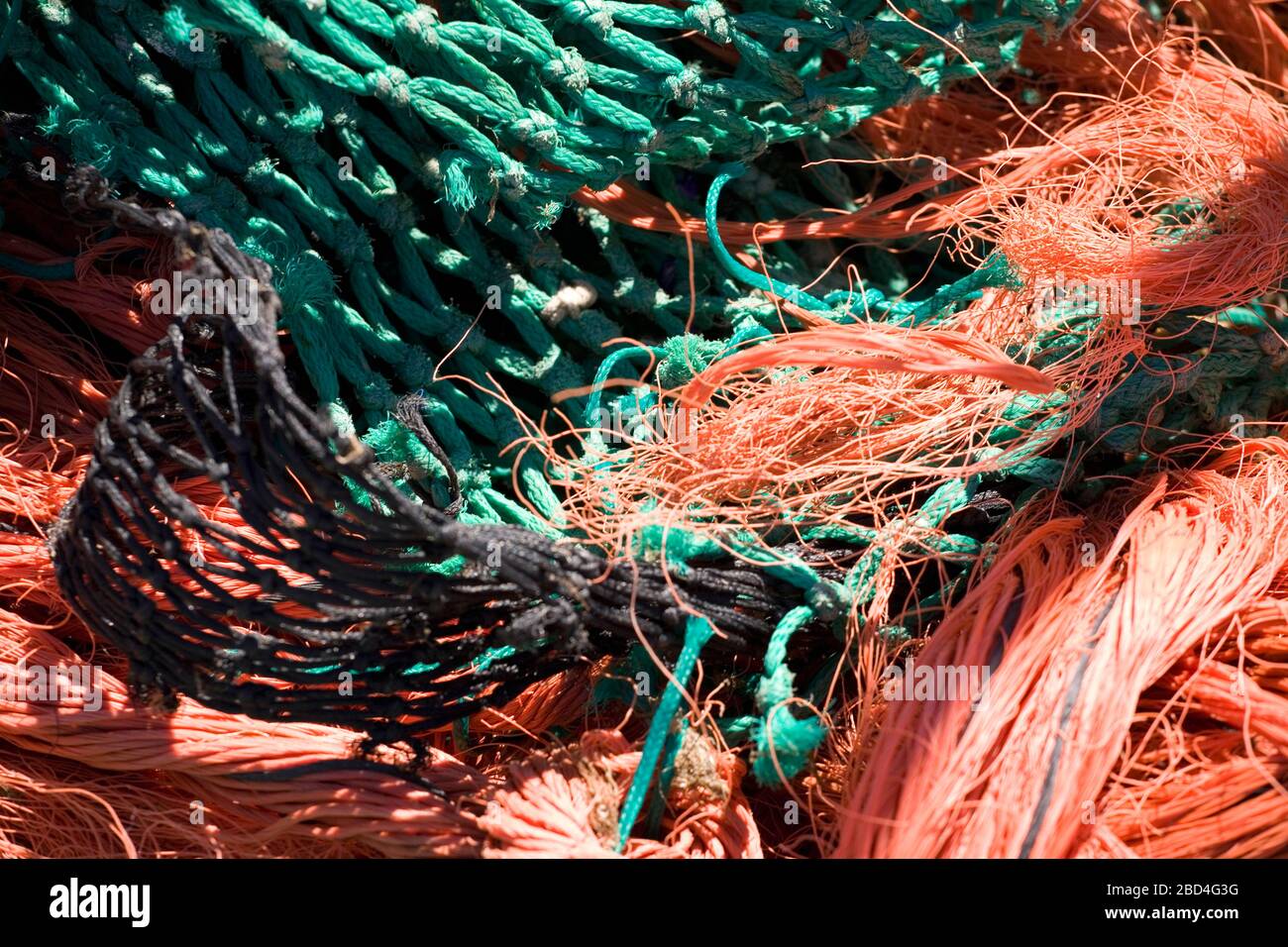 Brightly-coloured fishing nets drying in the sun, Camber Dock, Old ...