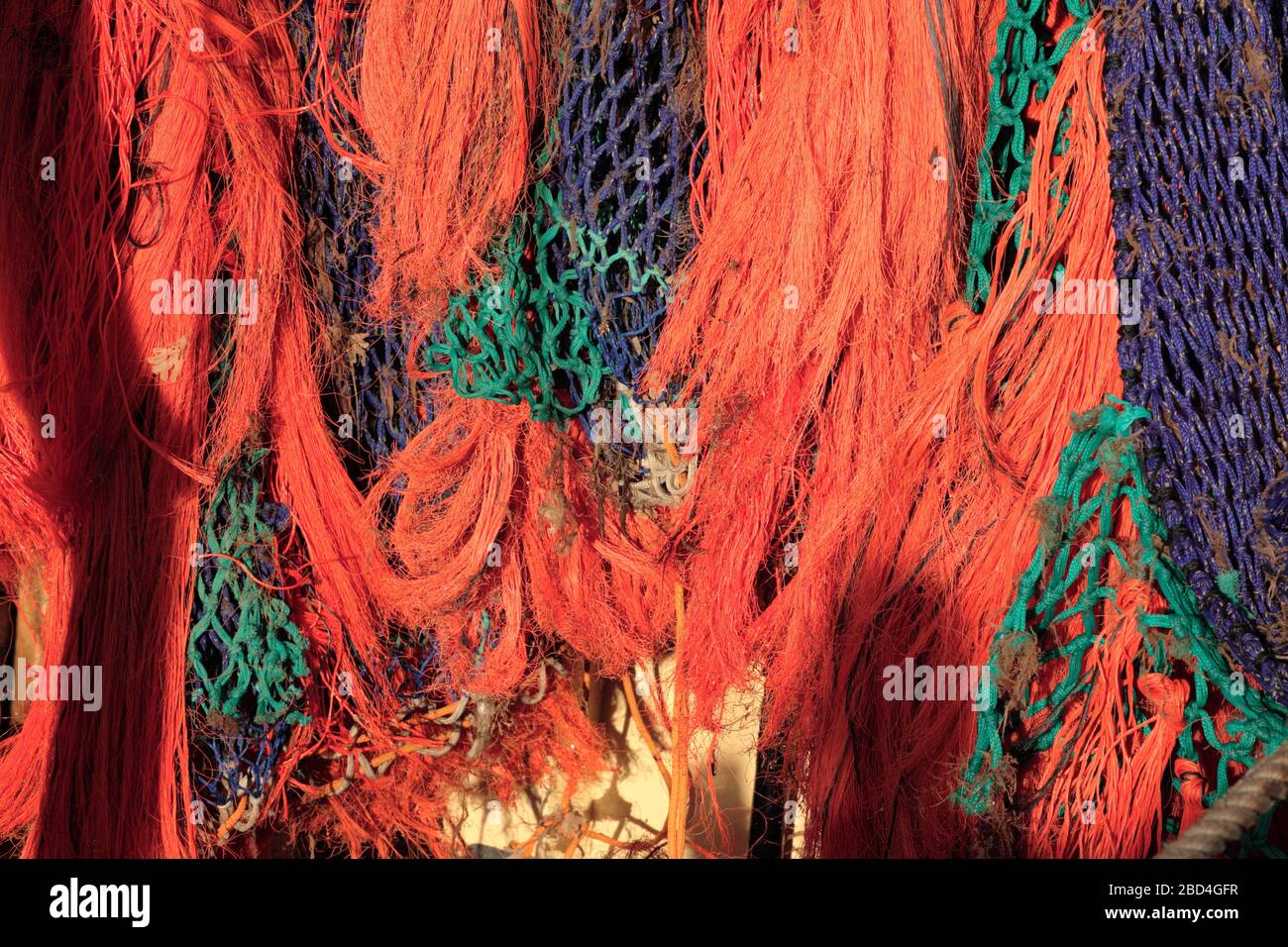 Brightly-coloured fishing nets drying in the sun, Camber Dock, Old ...
