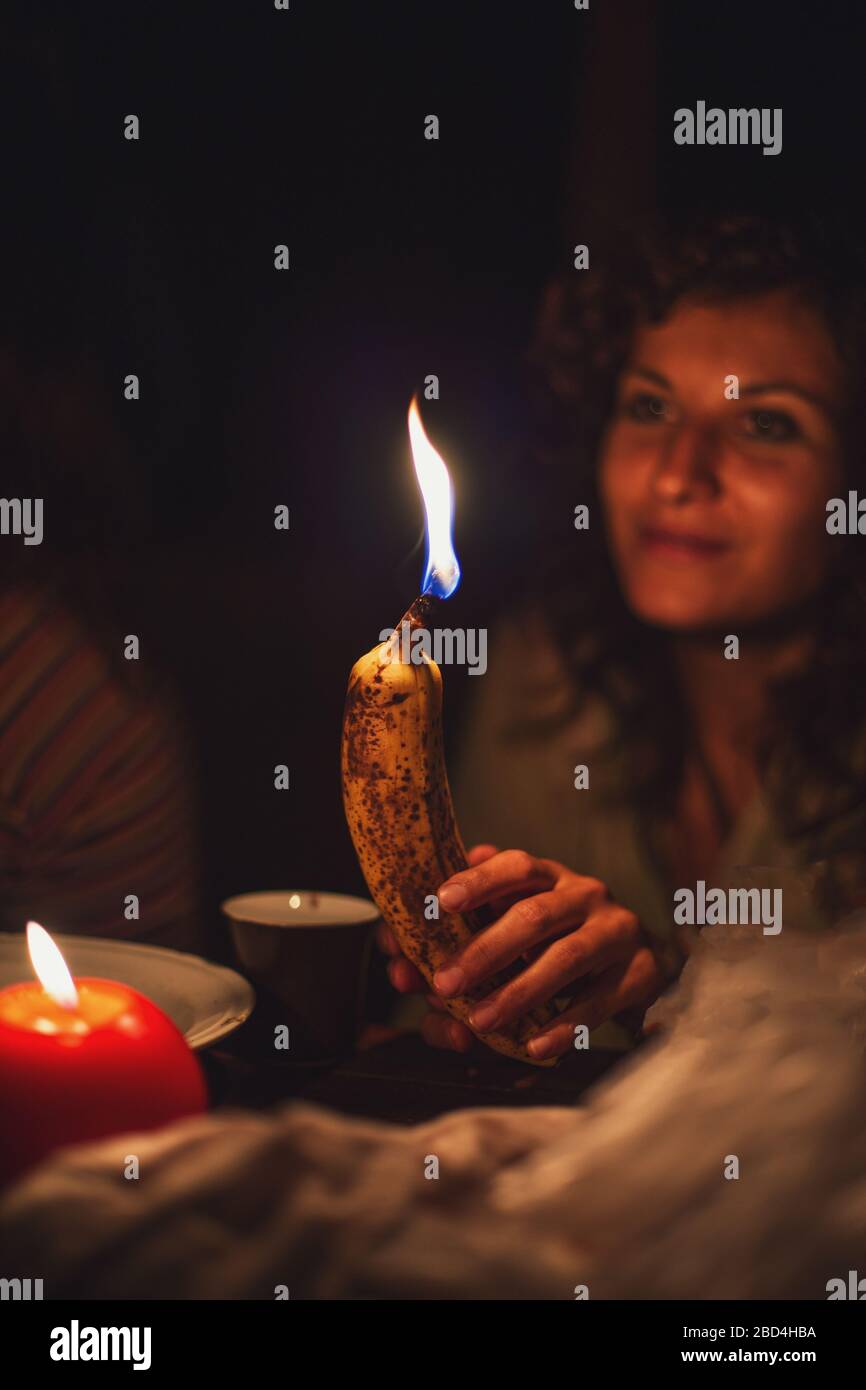 burning banana is a candle. Girl of candles Stock Photo - Alamy