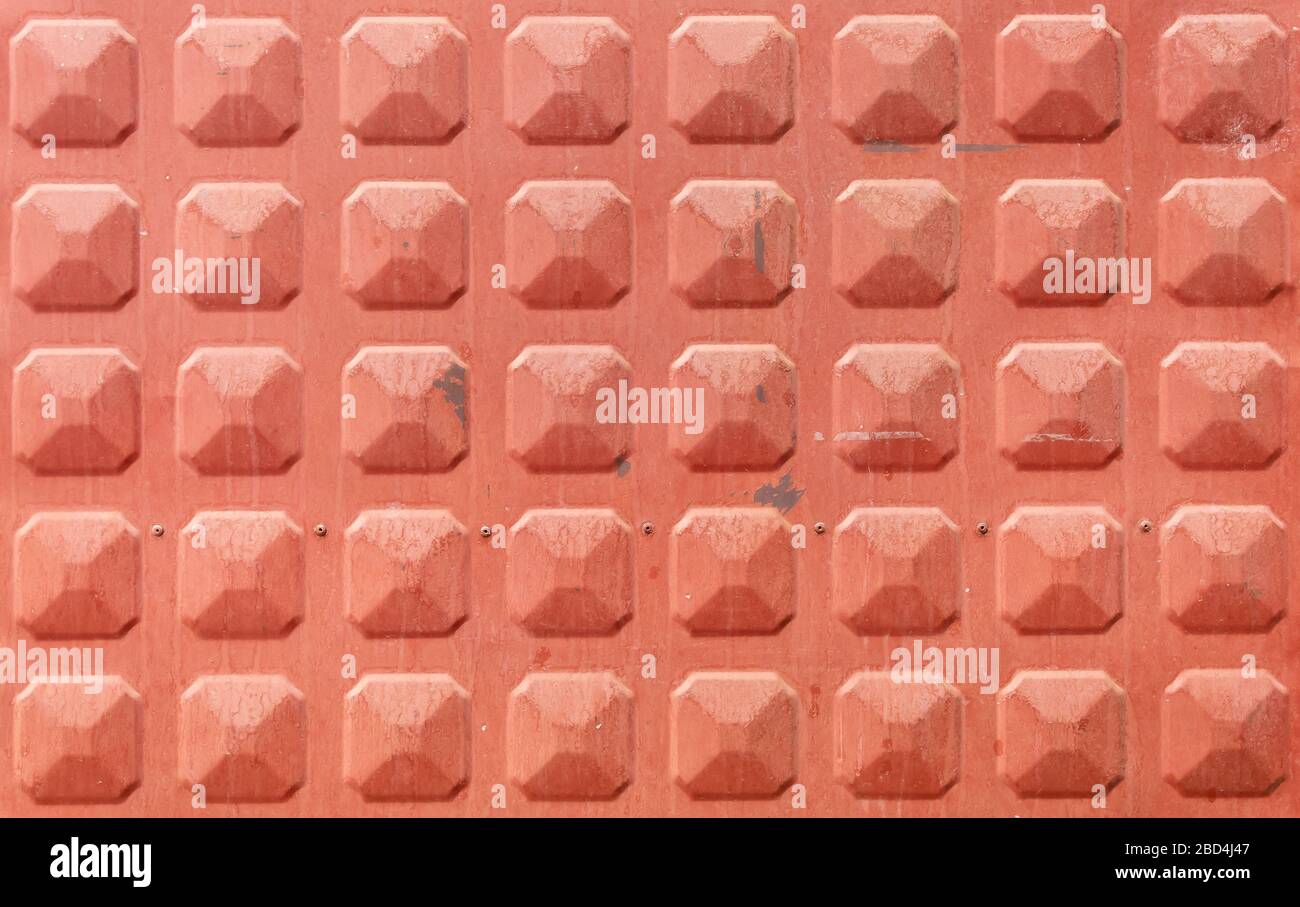 Red Painted Metal Texture With Repeating Elements Stock Photo - Alamy