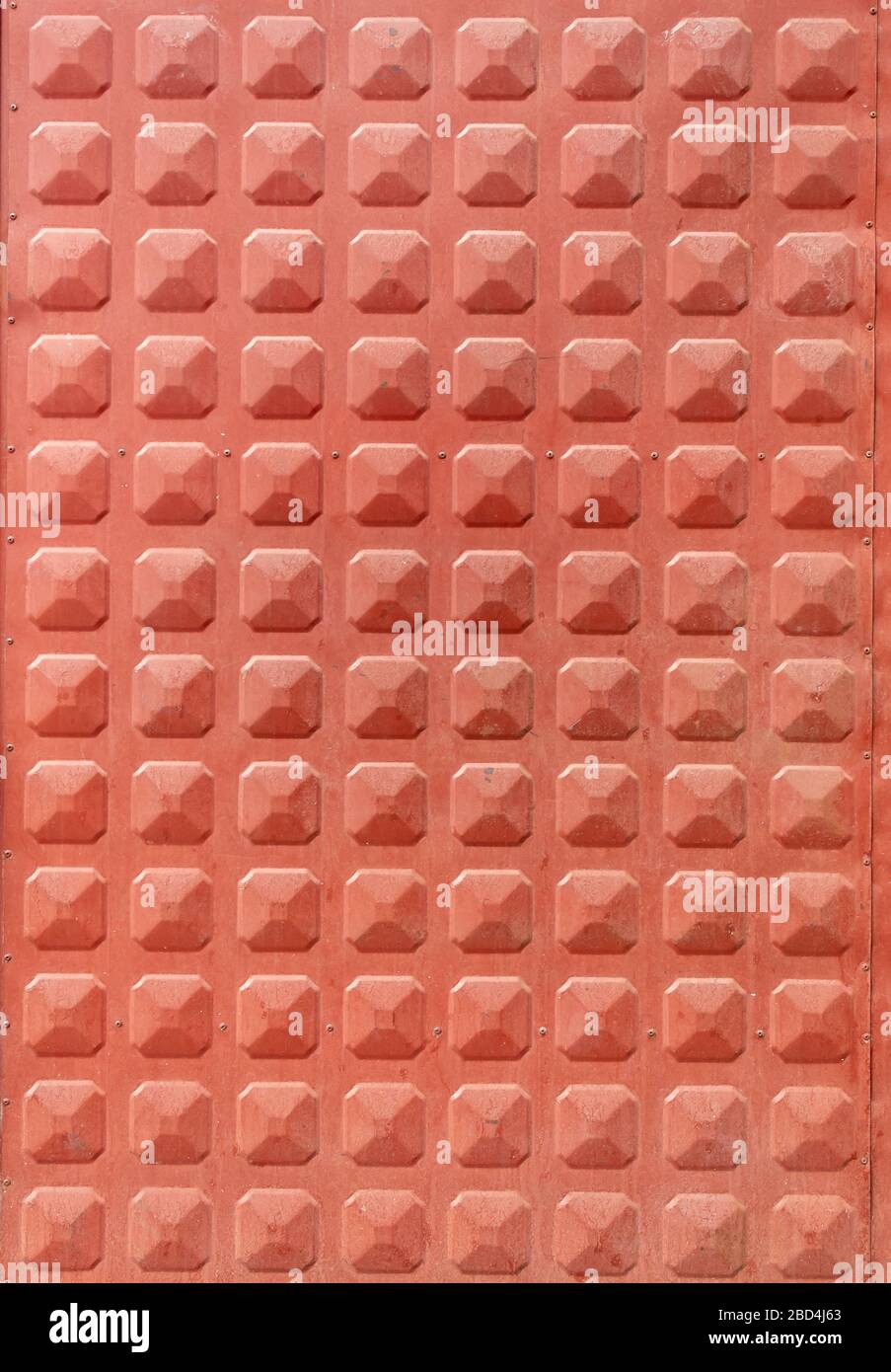 Red Painted Metal Texture With Repeating Elements Stock Photo - Alamy