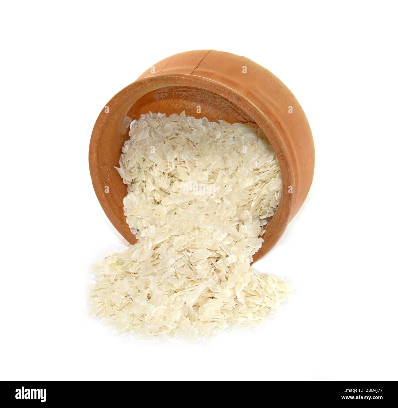 flattened rice flakes in a ceramic bowl isolated on white Stock Photo ...