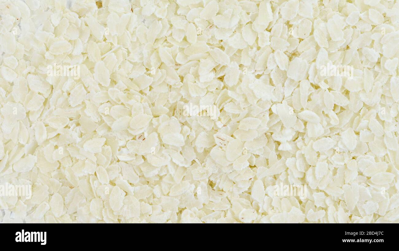 flattened rice flakes isolated on white Stock Photo - Alamy