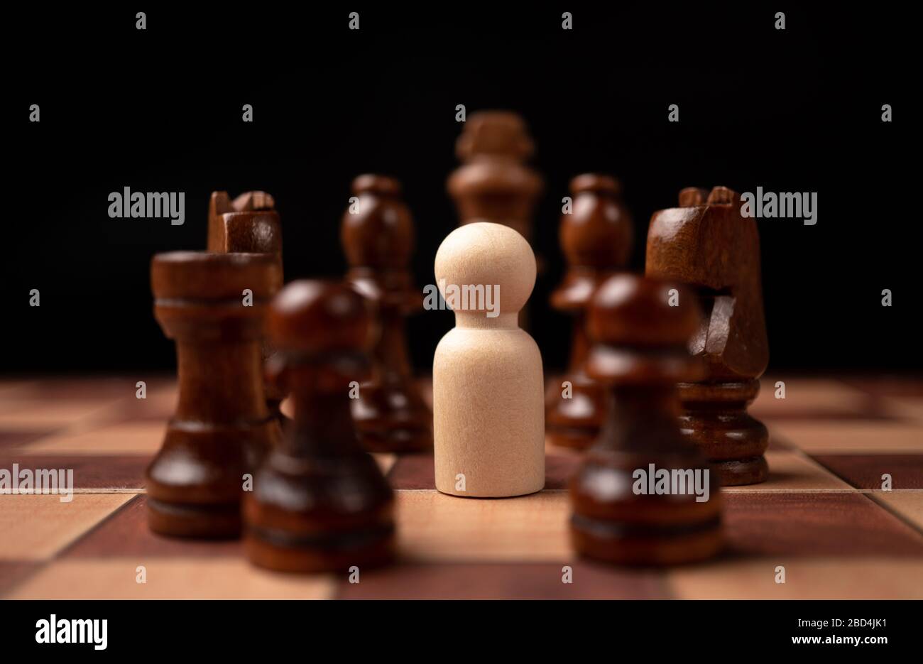 Wooden figures (businessman) standing confront of chess king and being ...