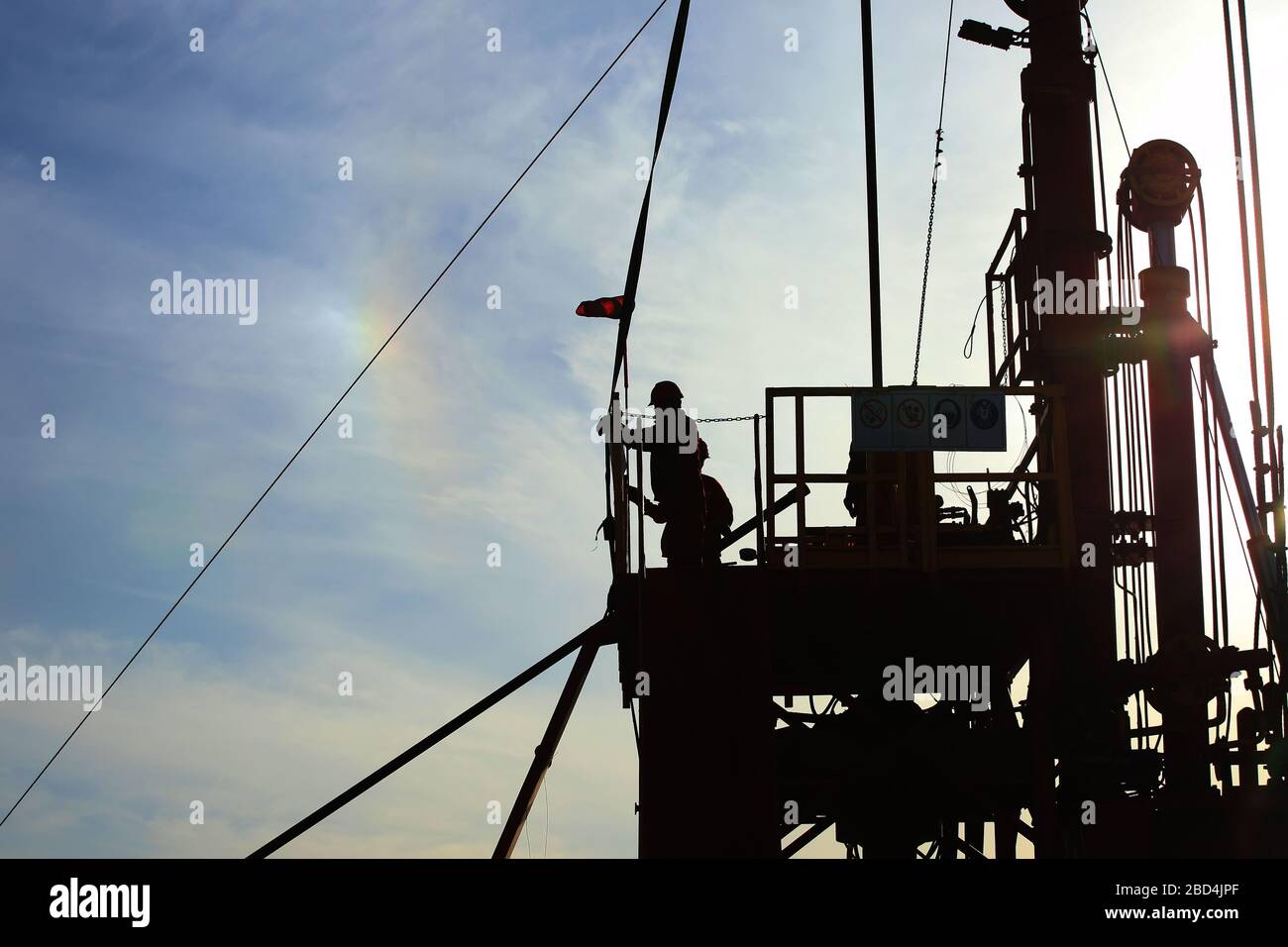 In the evening，oil field, the oil workers are working Stock Photo - Alamy