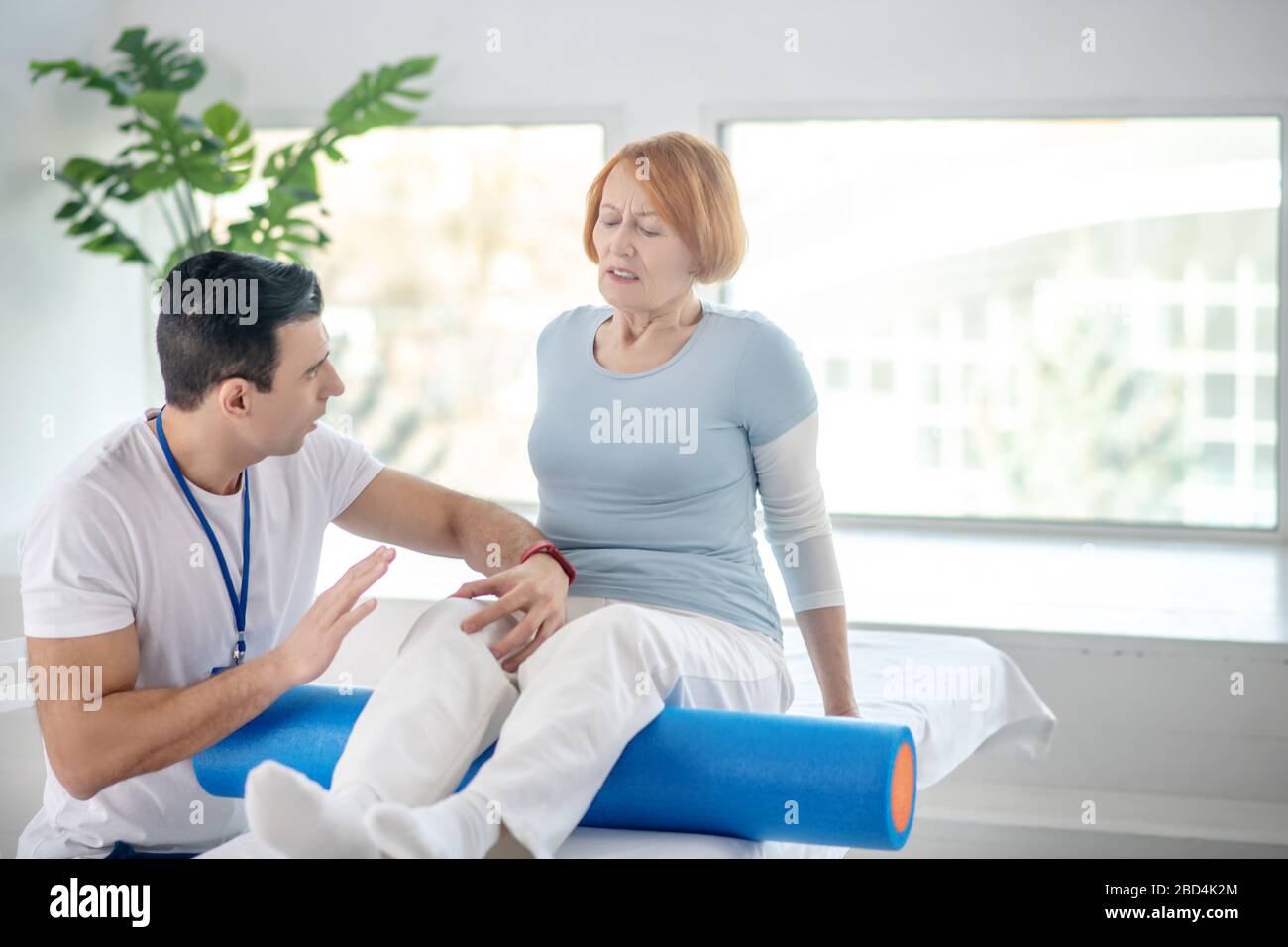 Nice young man calming down his patient Stock Photo - Alamy