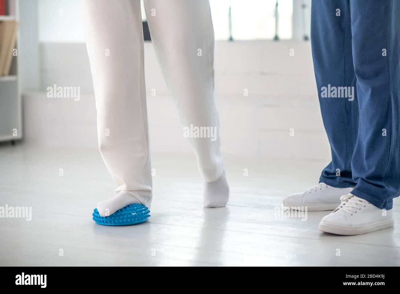 Physiotherapist training female patient exercise hi-res stock ...