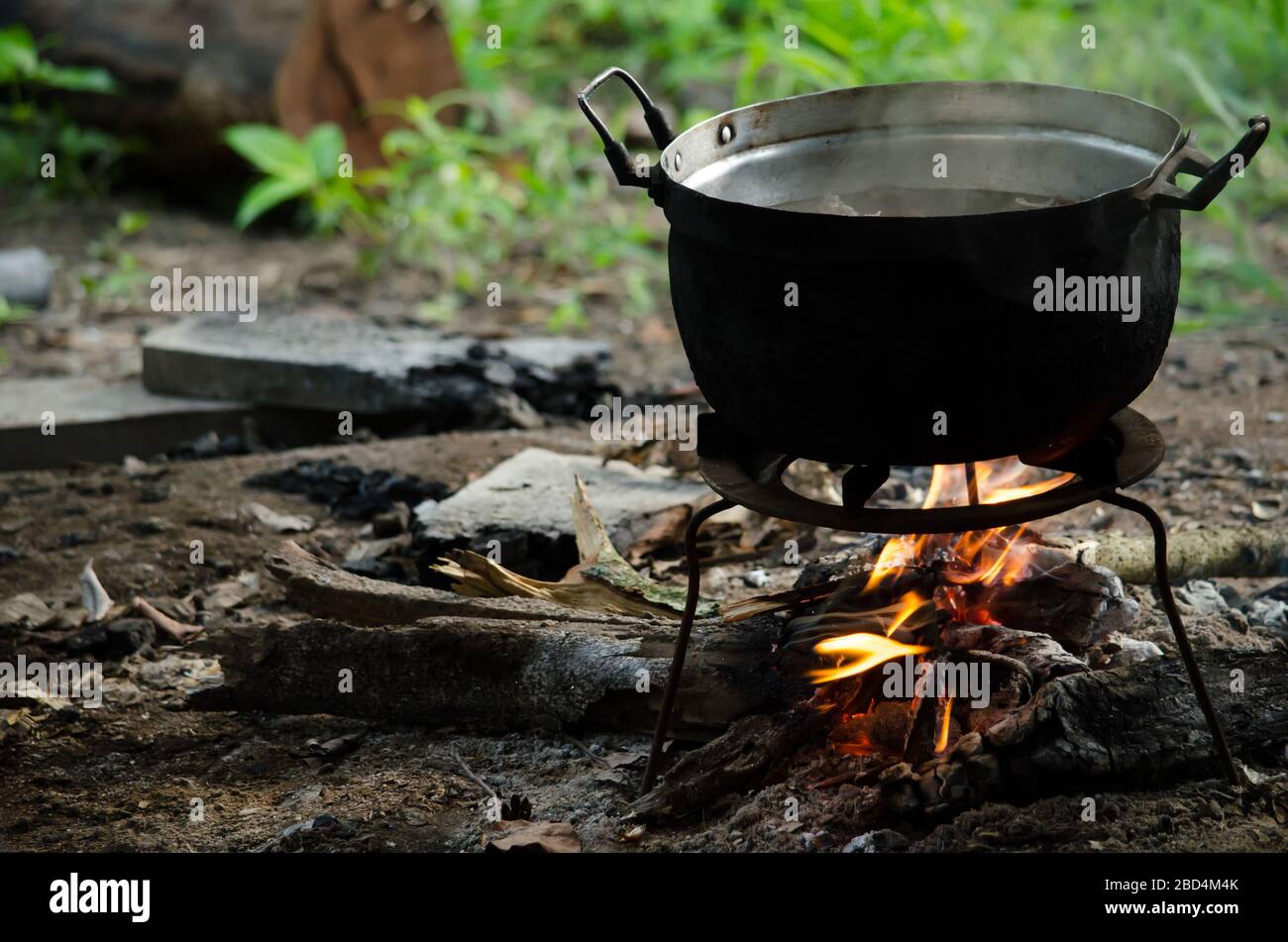 the bonfire is burning firewood under pot Stock Photo - Alamy