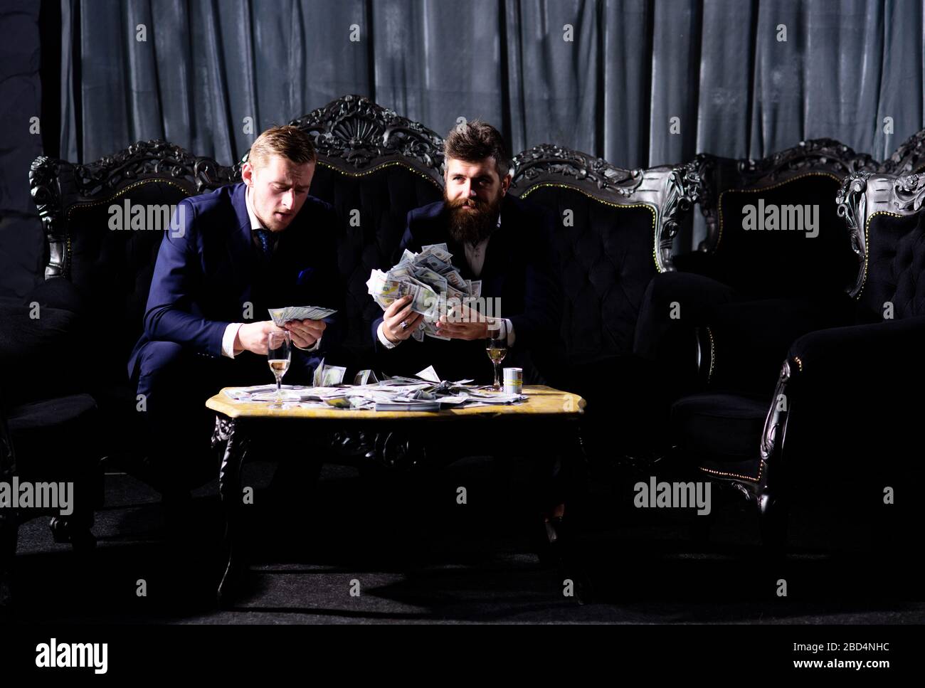 Illegal deal concept. Men in suit, businessmen sit in dark luxury ...
