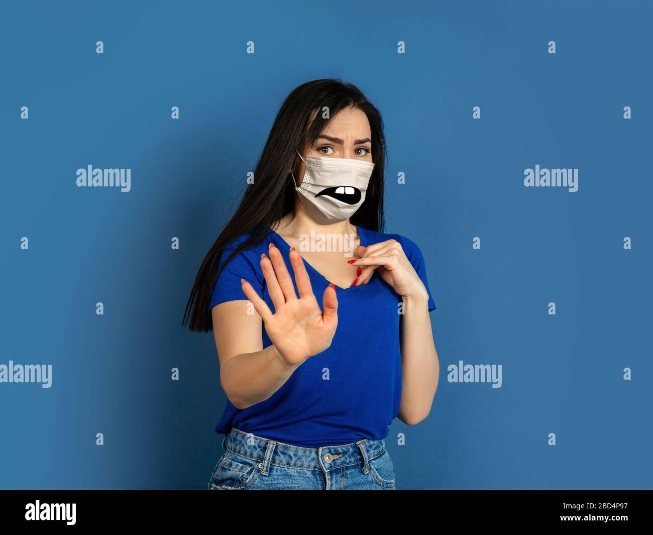 Scared.Portrait of young caucasian woman with emotion on her protective ...