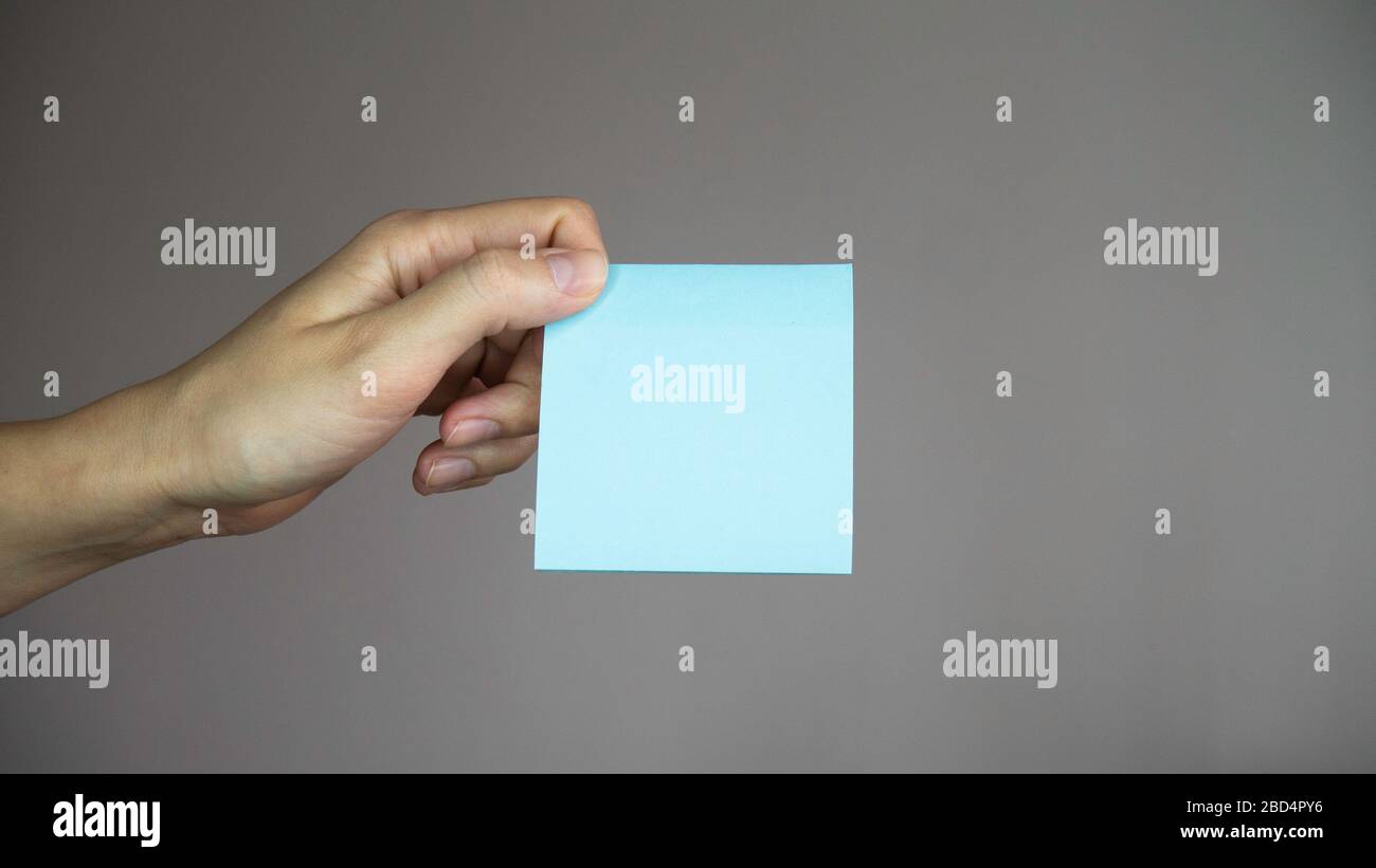 Hand holding a blank sticker Stock Photo - Alamy