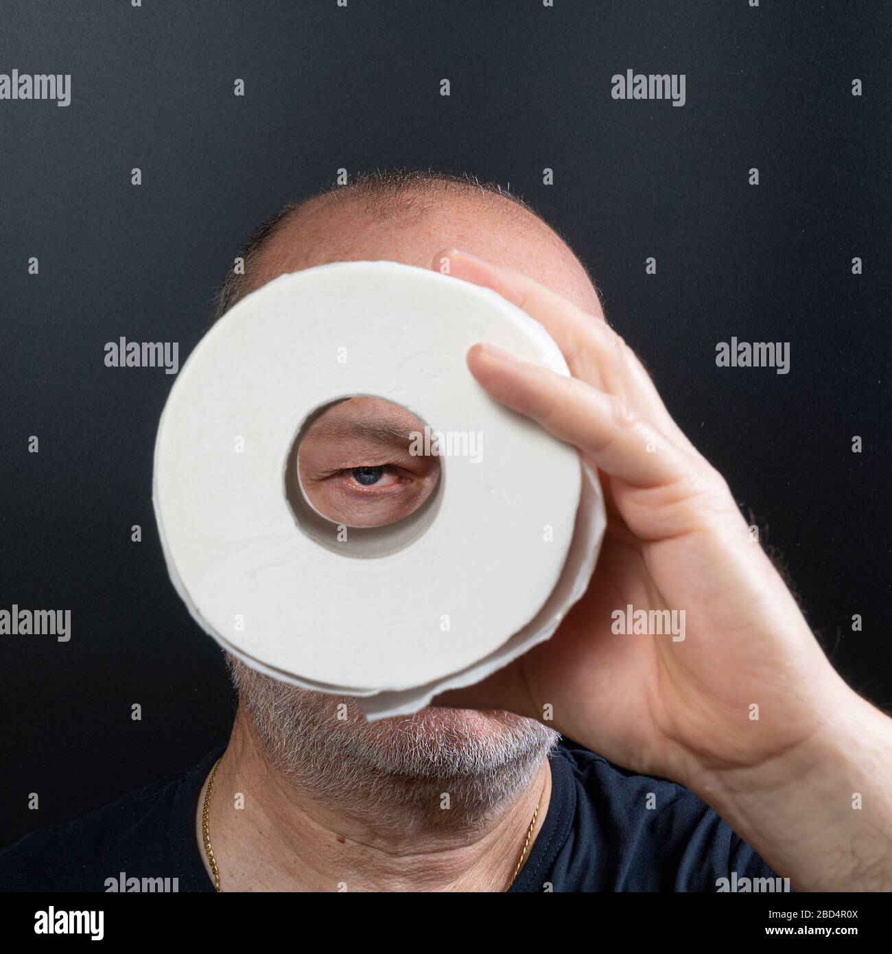 a man looks through a roll of toilet paper Stock Photo - Alamy