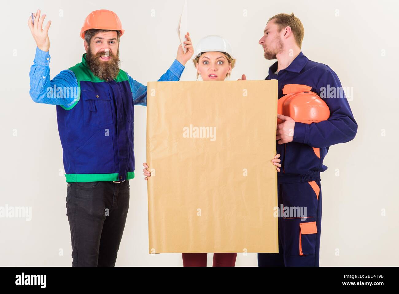 Men and woman in helmets, architects on confused face with drawing ...