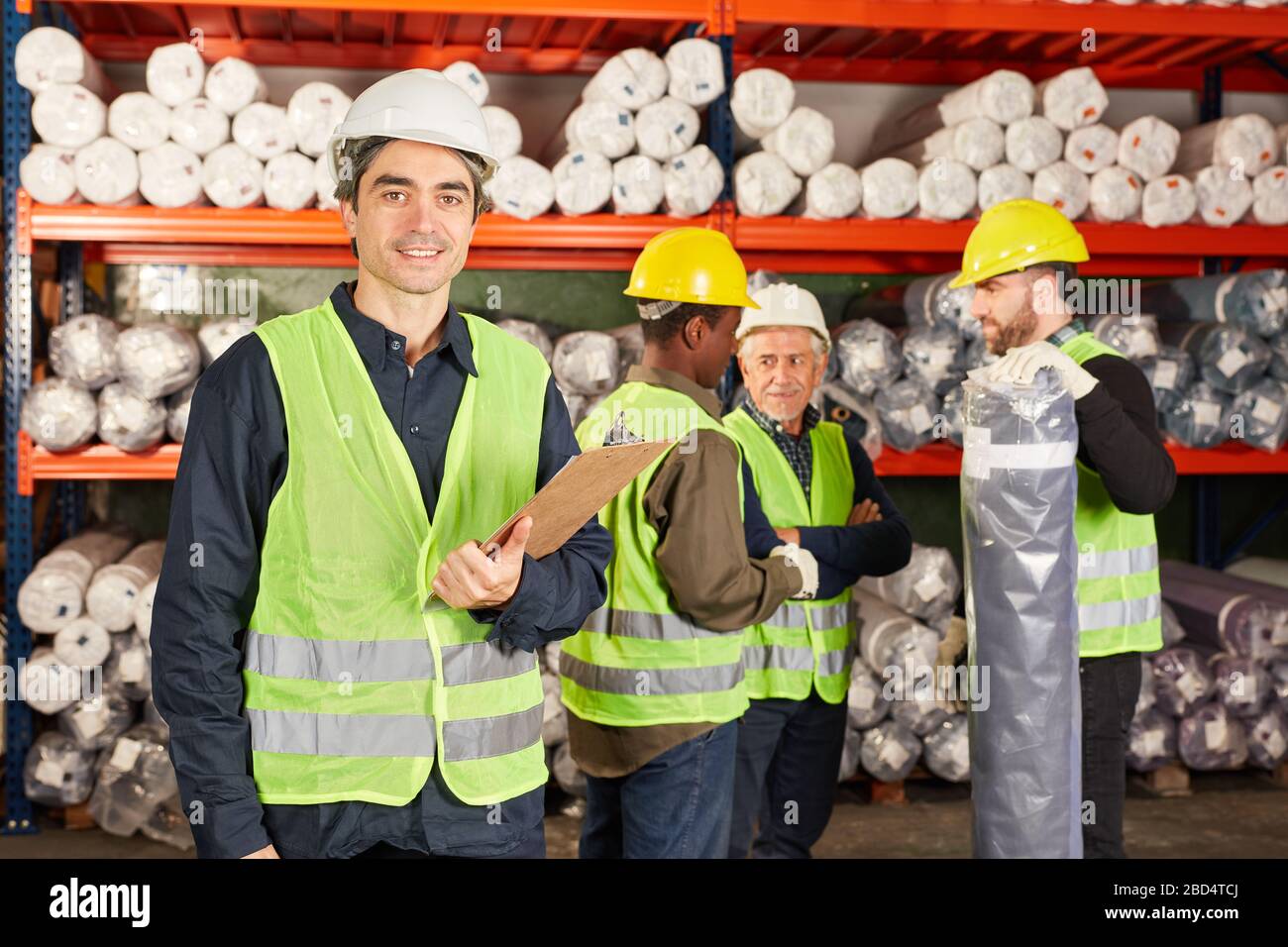 Warehouse workers team work together in a factory carpet store Stock ...