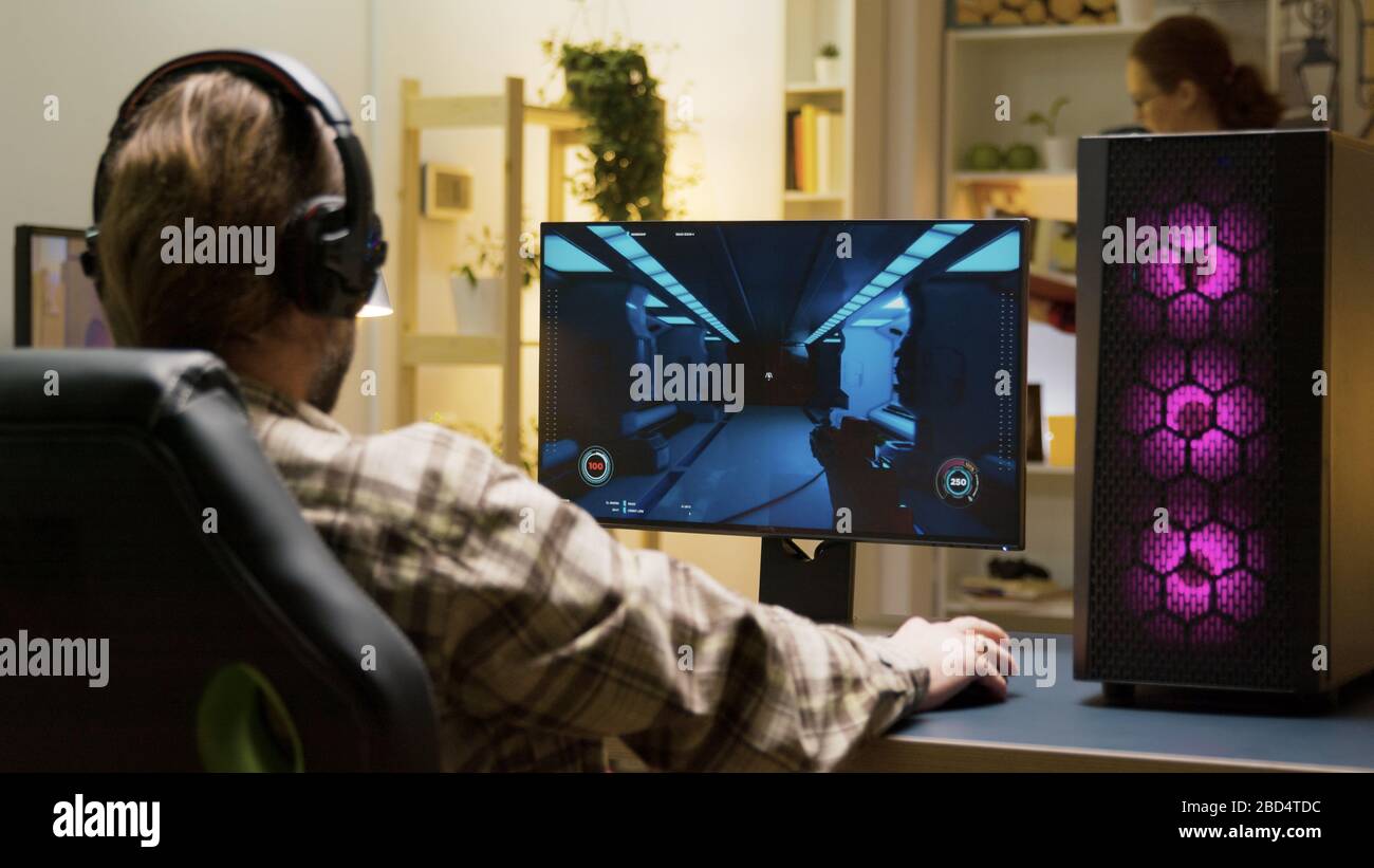 Man stretching before starting to play video games on computer sitting ...
