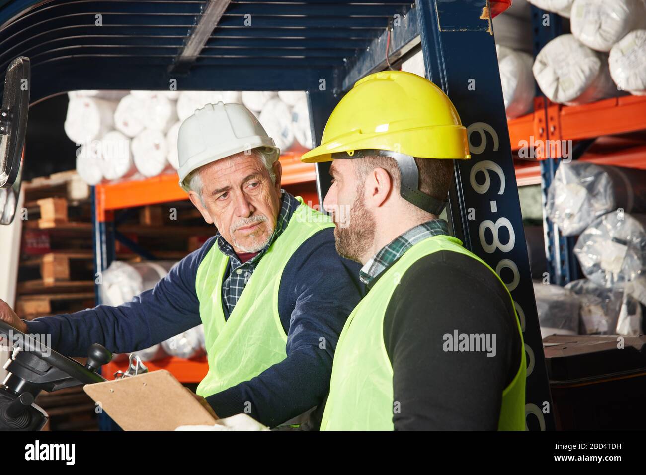 Logistics workers and order pickers pick up goods in industrial ...
