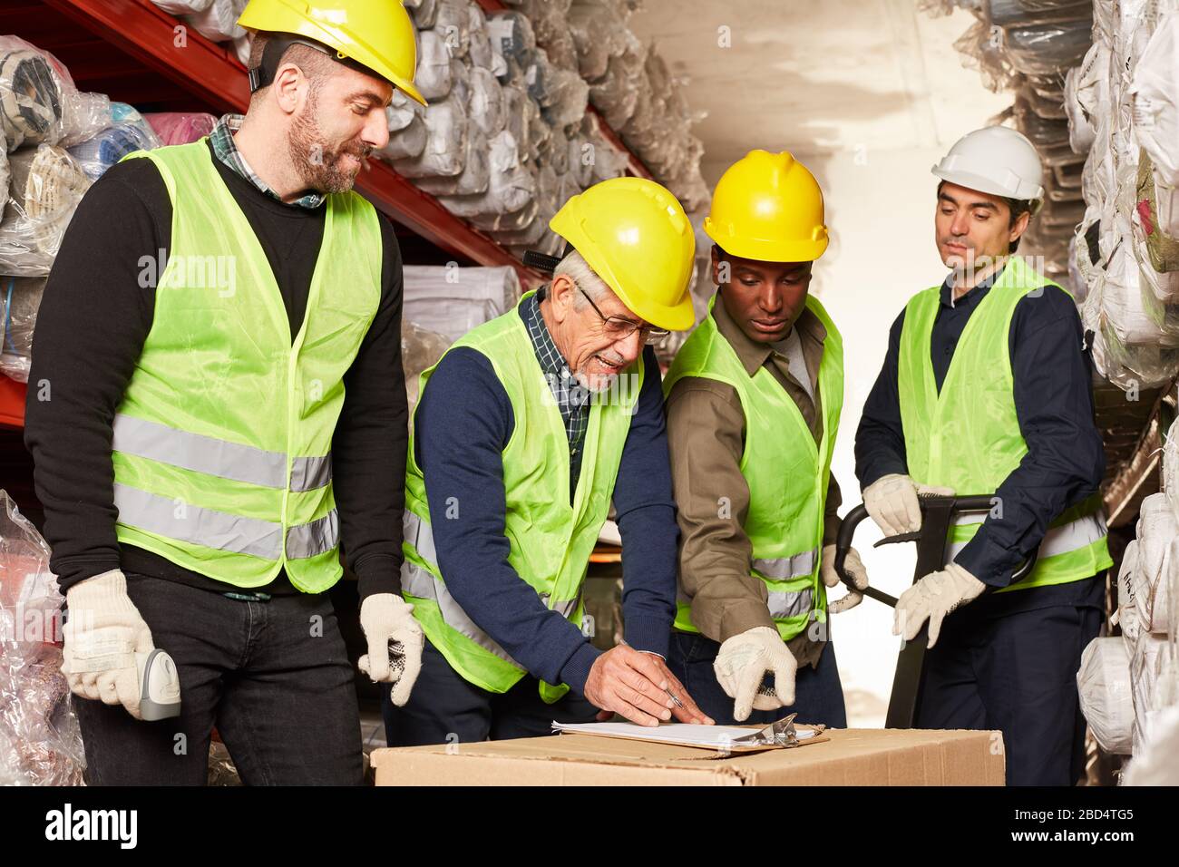 Pickers and warehouse workers in the warehouse with package and ...