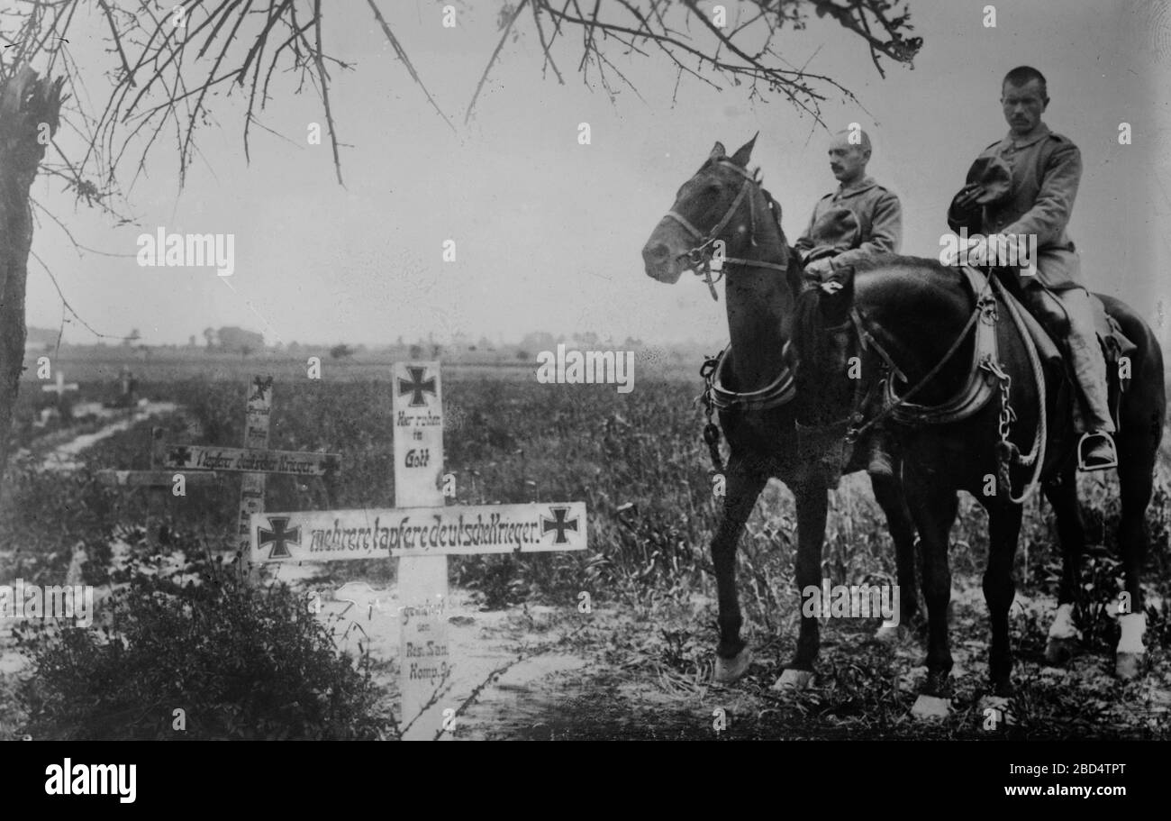 German soldiers on horseback mourning at graves of soldiers on the ...