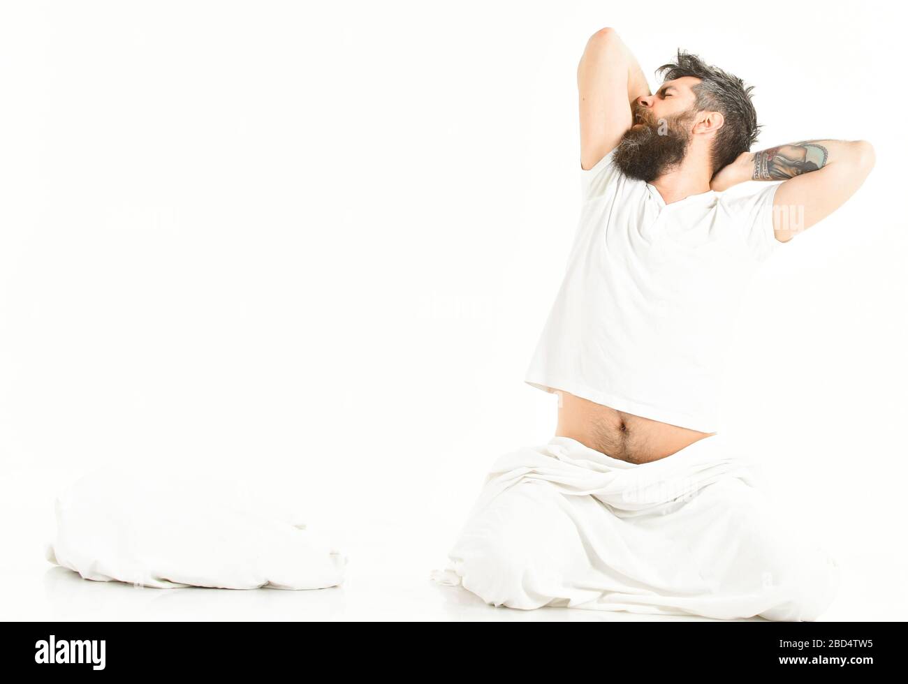 Good morning concept. Hipster with beard stretching arms, energetic and ...