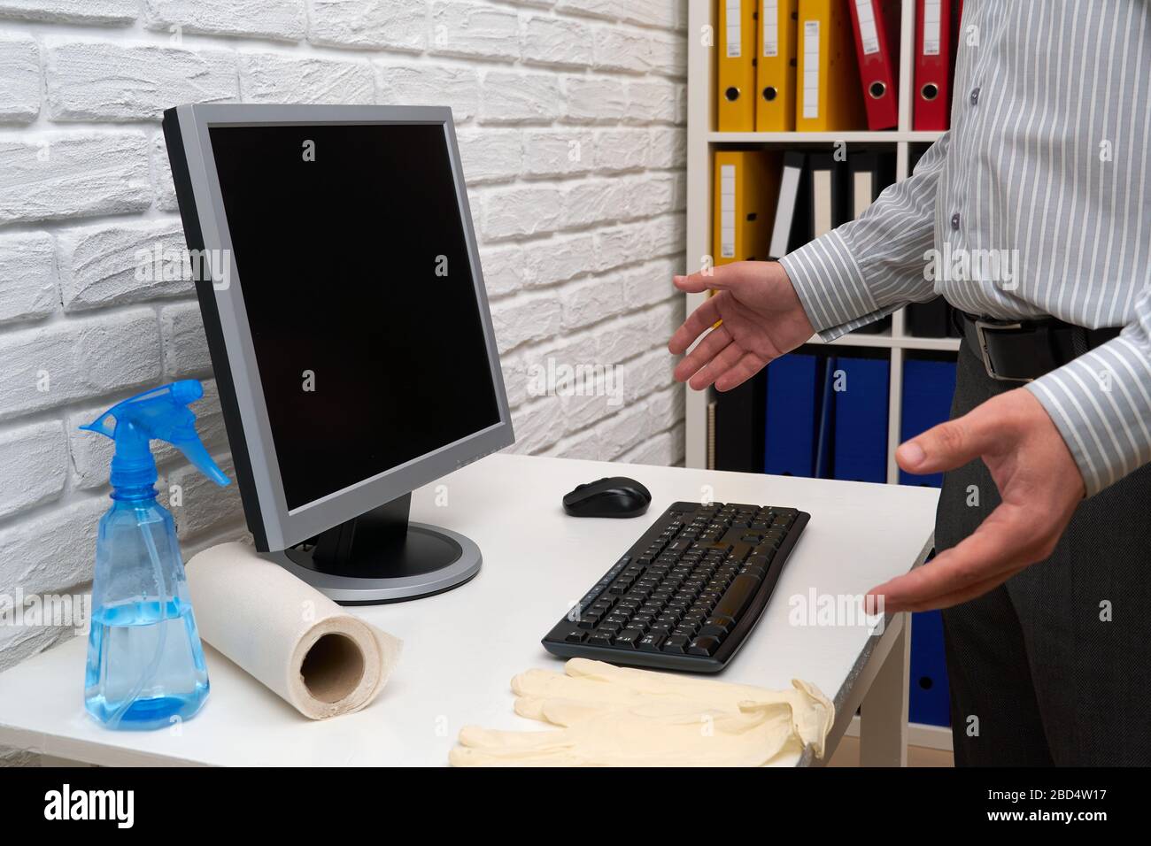 concept of cleaning or disinfecting the office - a businessman cleans ...
