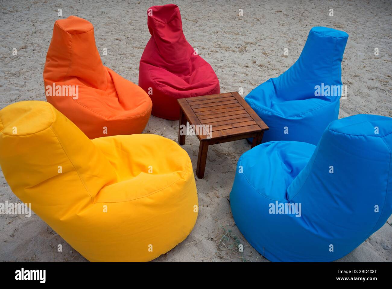 Place for relax on the sand beach. Multicolored seats looking like an ...