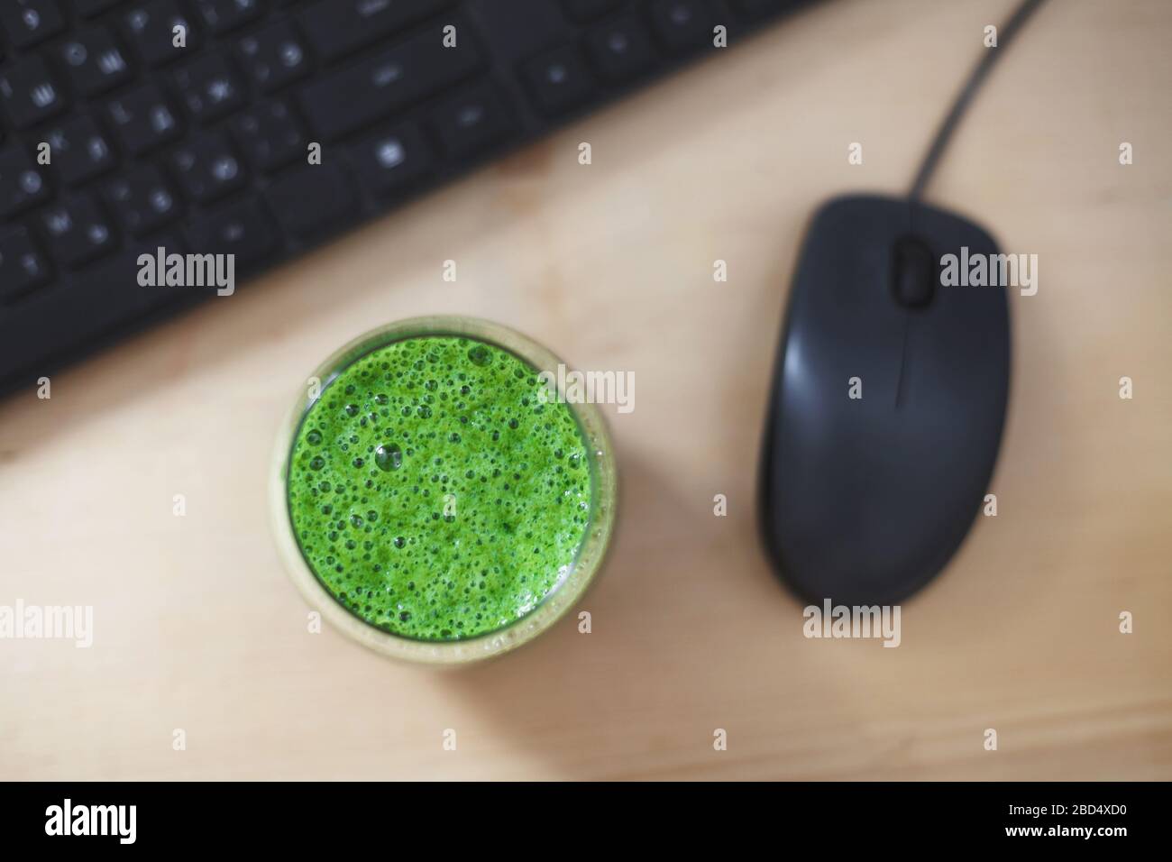 Top view of green smoothie on wooden work desk. Concept of healthy ...