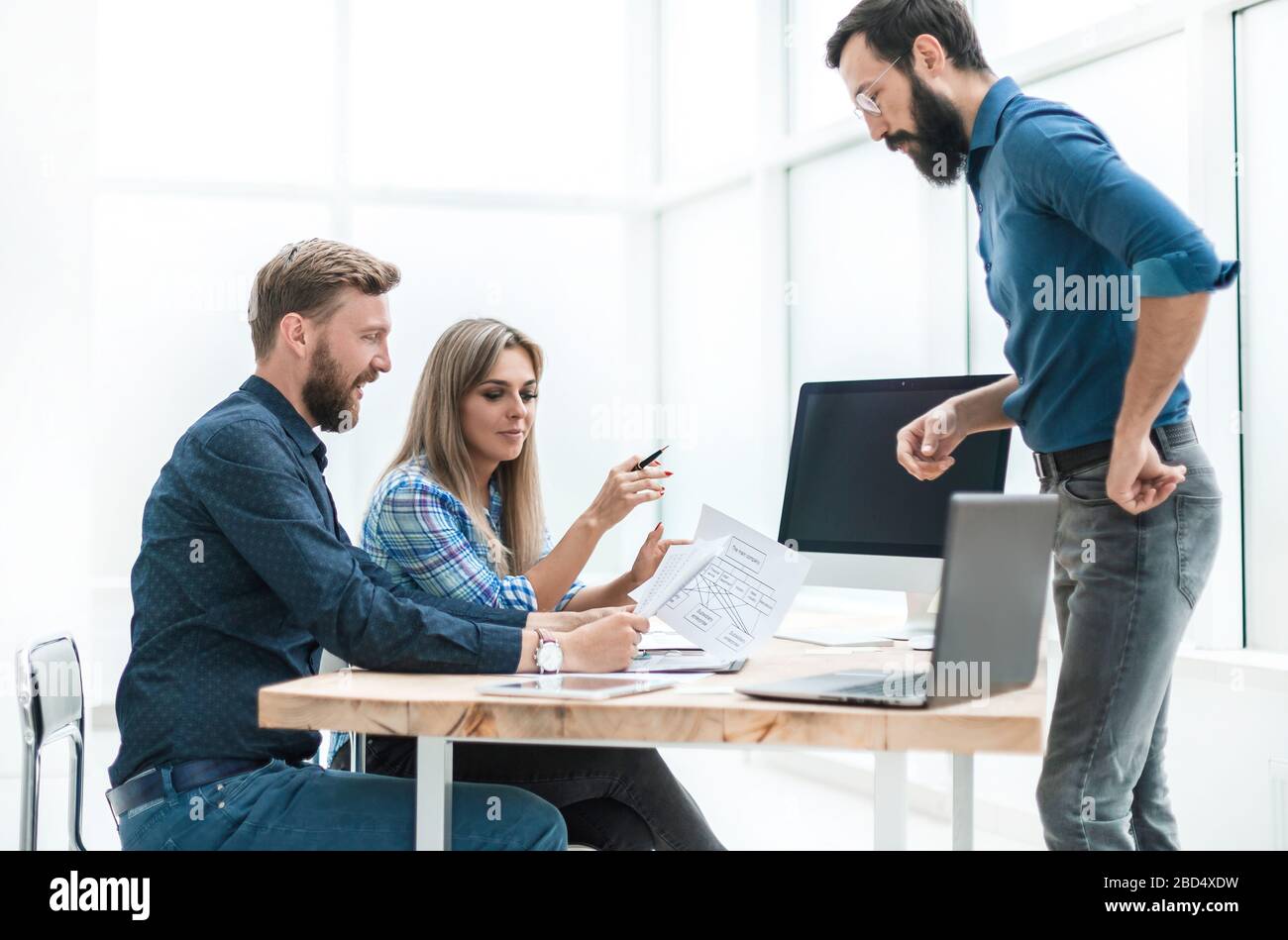 group of business people discussing something near the office Desk ...