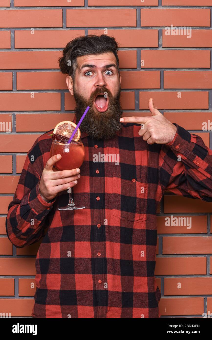 Bartender recommends to try beverage. Man in checkered shirt pointing ...