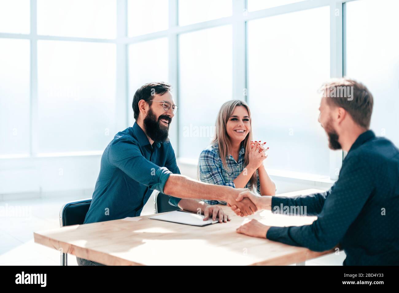 Interviewer handshaking the applicant hi-res stock photography and ...