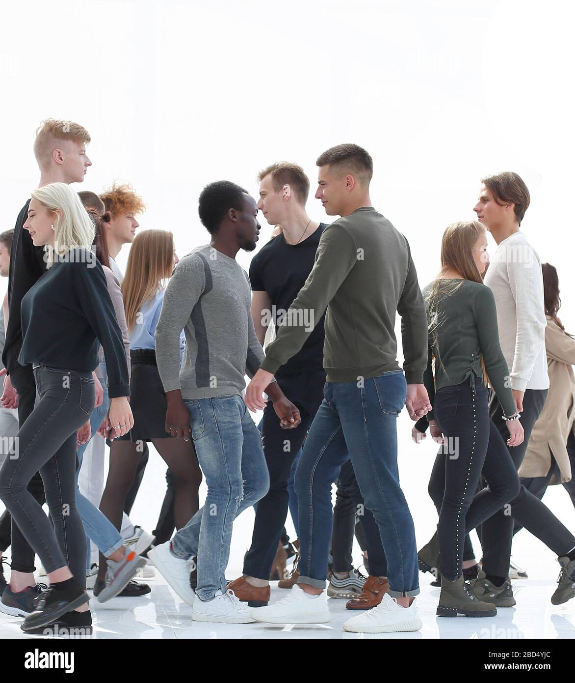 in full growth. diverse young people walking in different directions ...