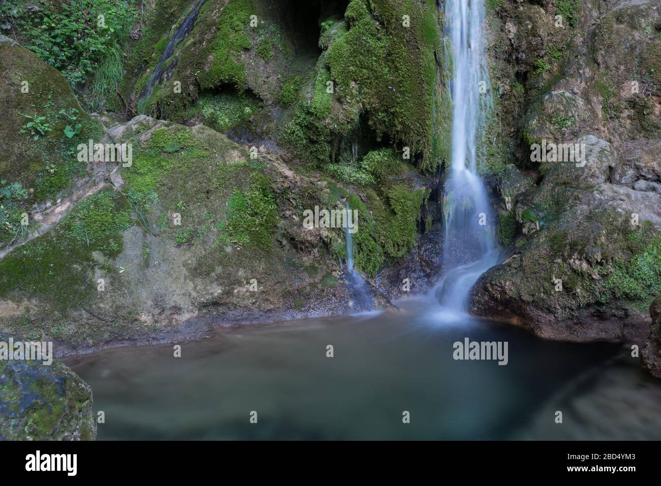 Water run down the rock which has scaled with time. Waterfall finishes ...