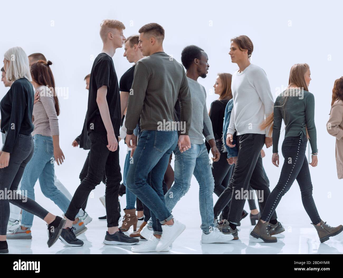 in full growth. diverse young people walking in different directions ...