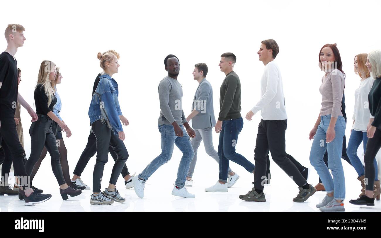 in full growth. diverse young people walking in different directions ...