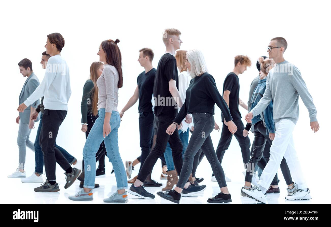 in full growth. diverse young people walking in different directions ...