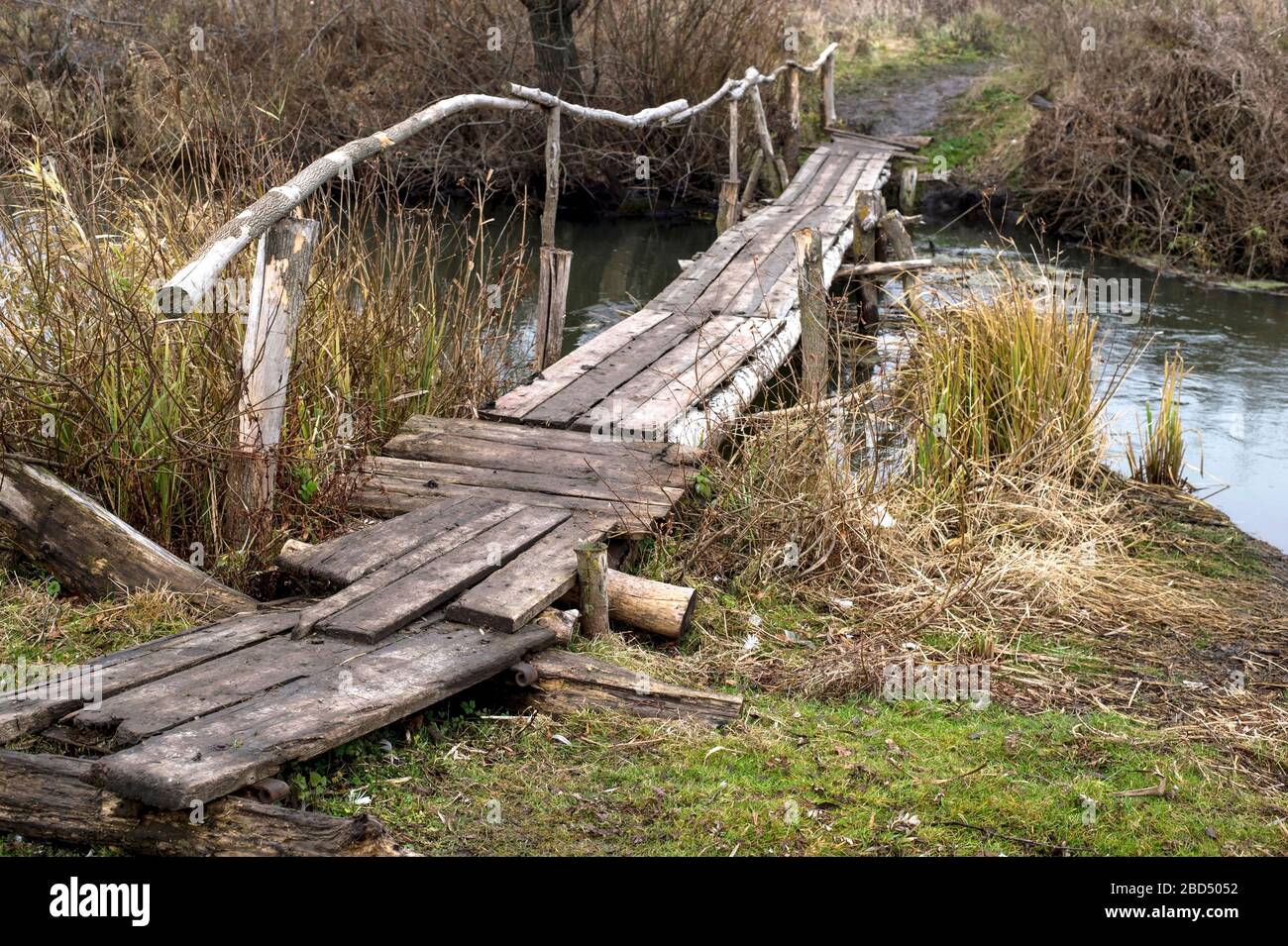 Wooden bridge over a small river in the village in autumn. Background ...
