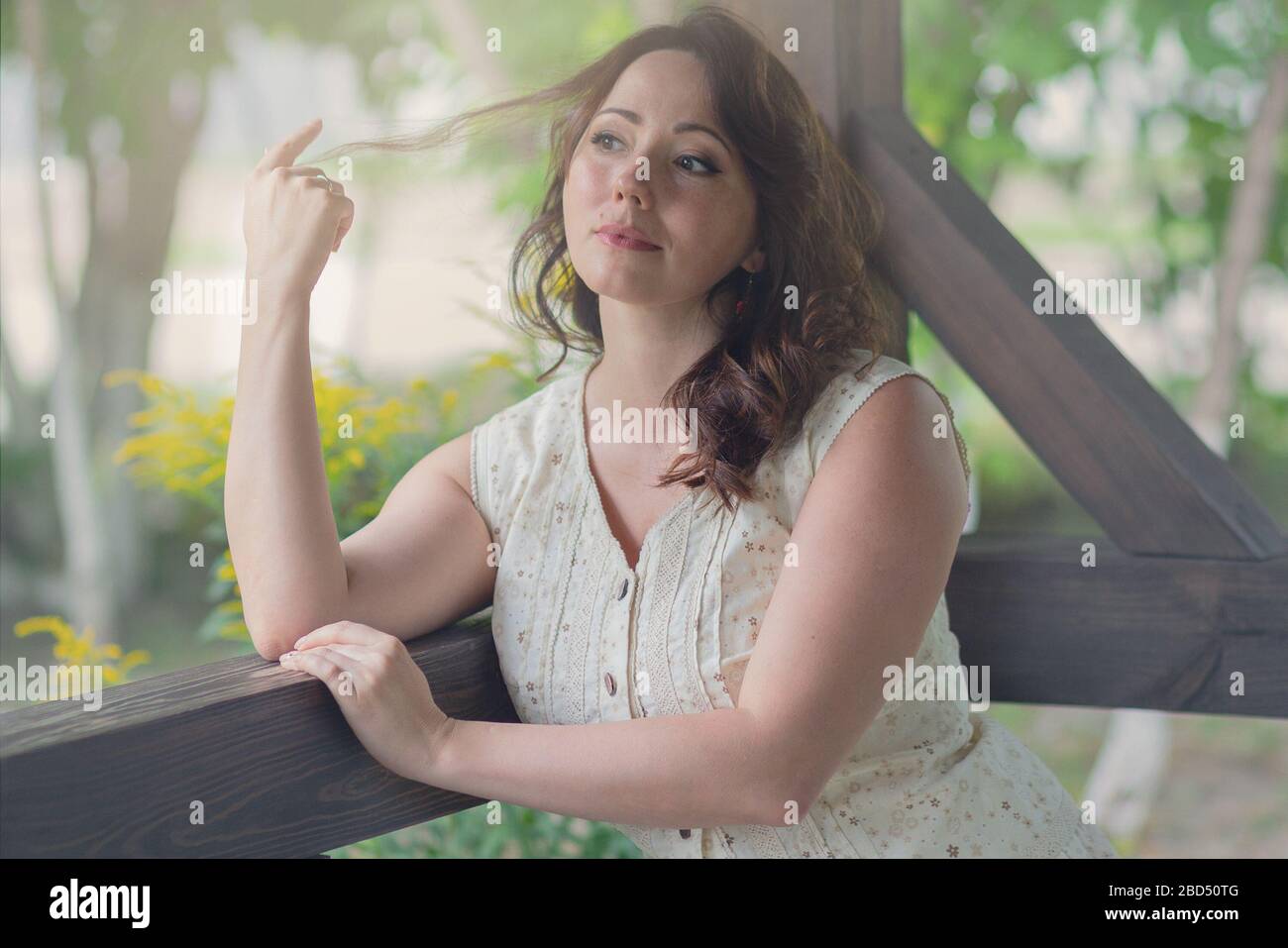 Beautiful flirtatious woman in the gazebo. People Stock Photo - Alamy