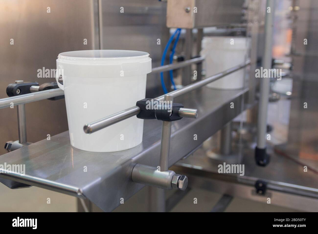 Plastic packaging for the food on the assembly line at a modern plant ...